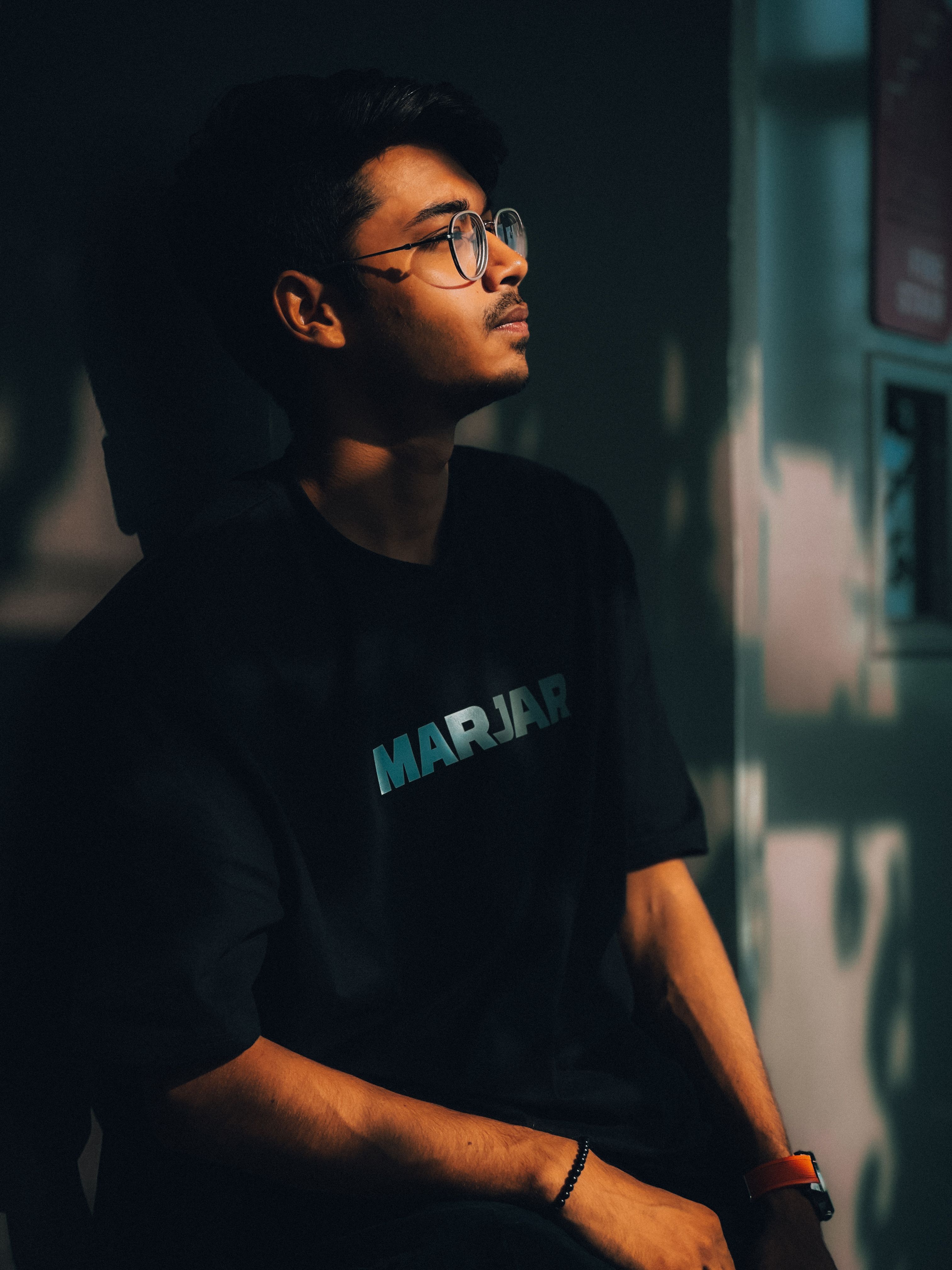 Contemplative Young Man in Dramatic Lighting · Free Stock Photo