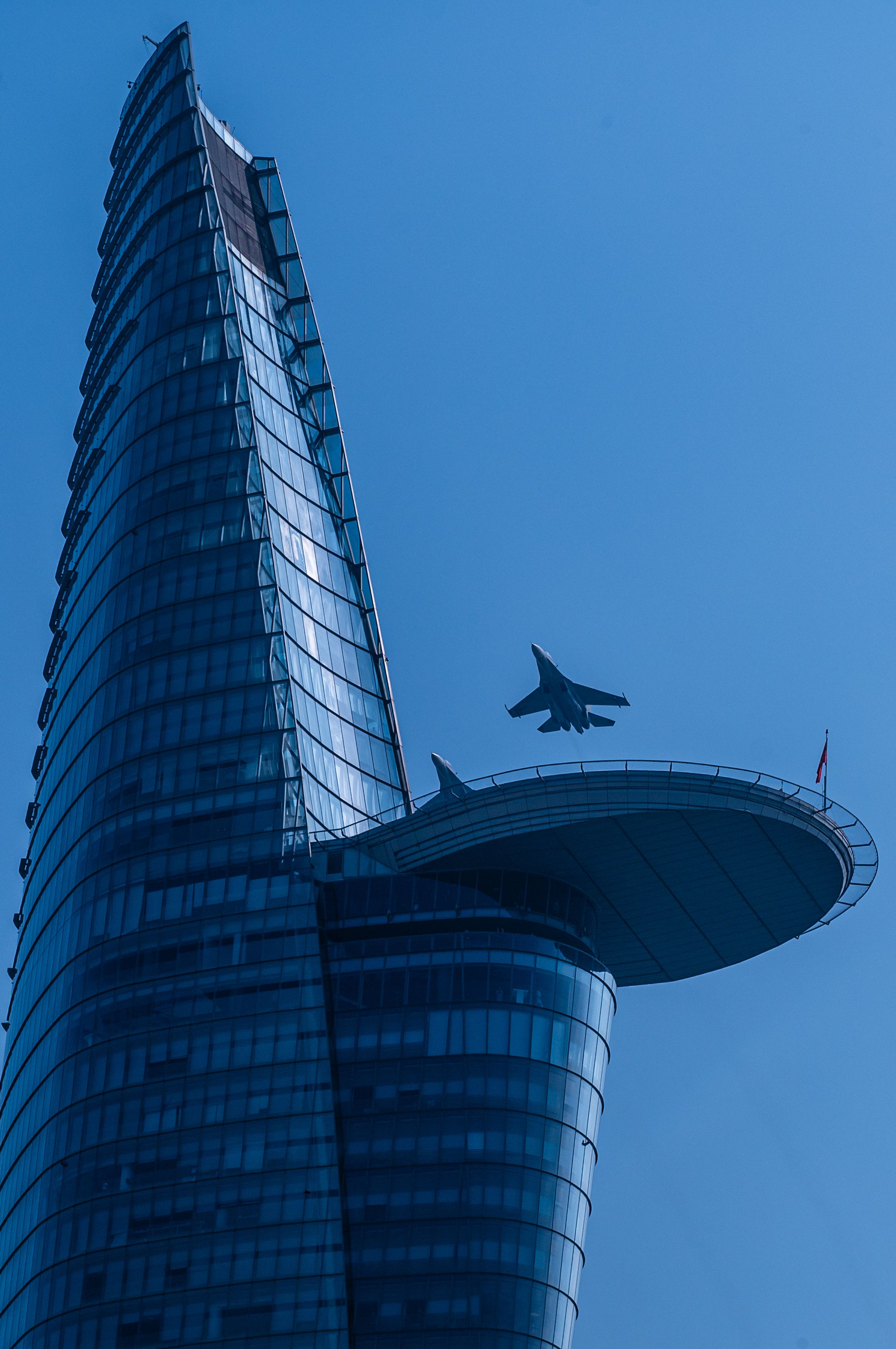 Jet Fighter Over Bitexco Financial Tower · Free Stock Photo