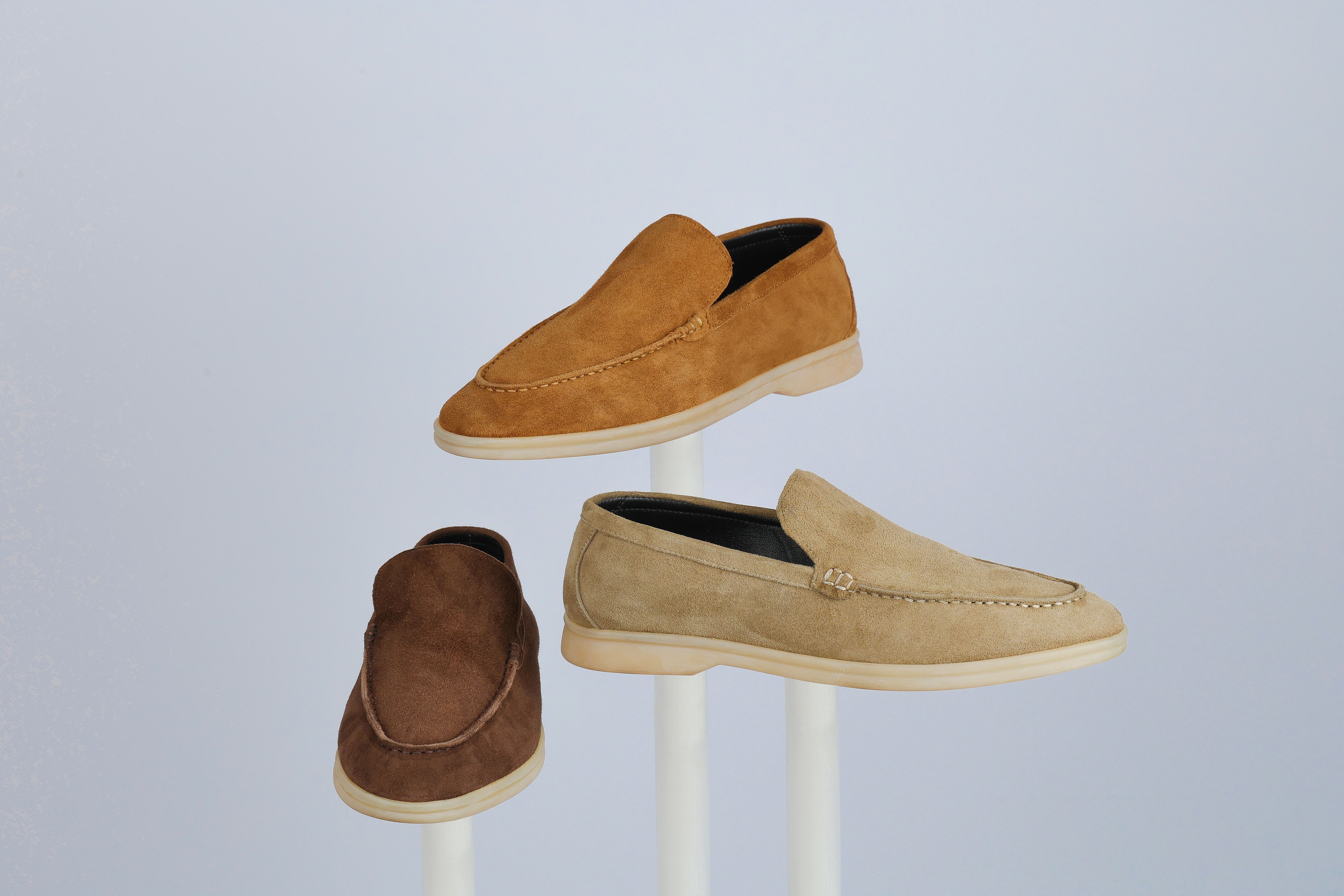 Elegant display of suede loafers in neutral tones · Free Stock Photo