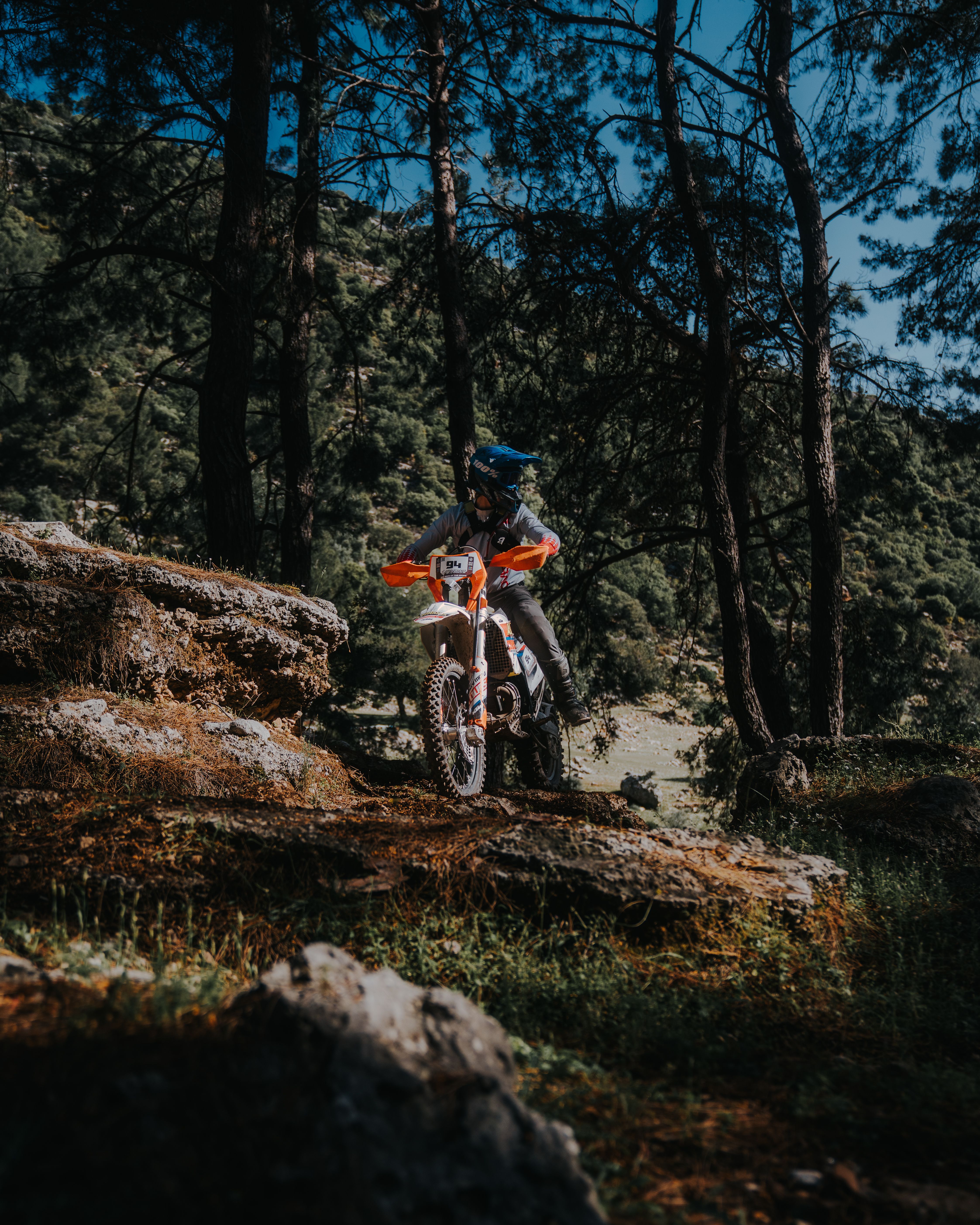 Motorcyclist Riding Through a Forest Trail · Free Stock Photo