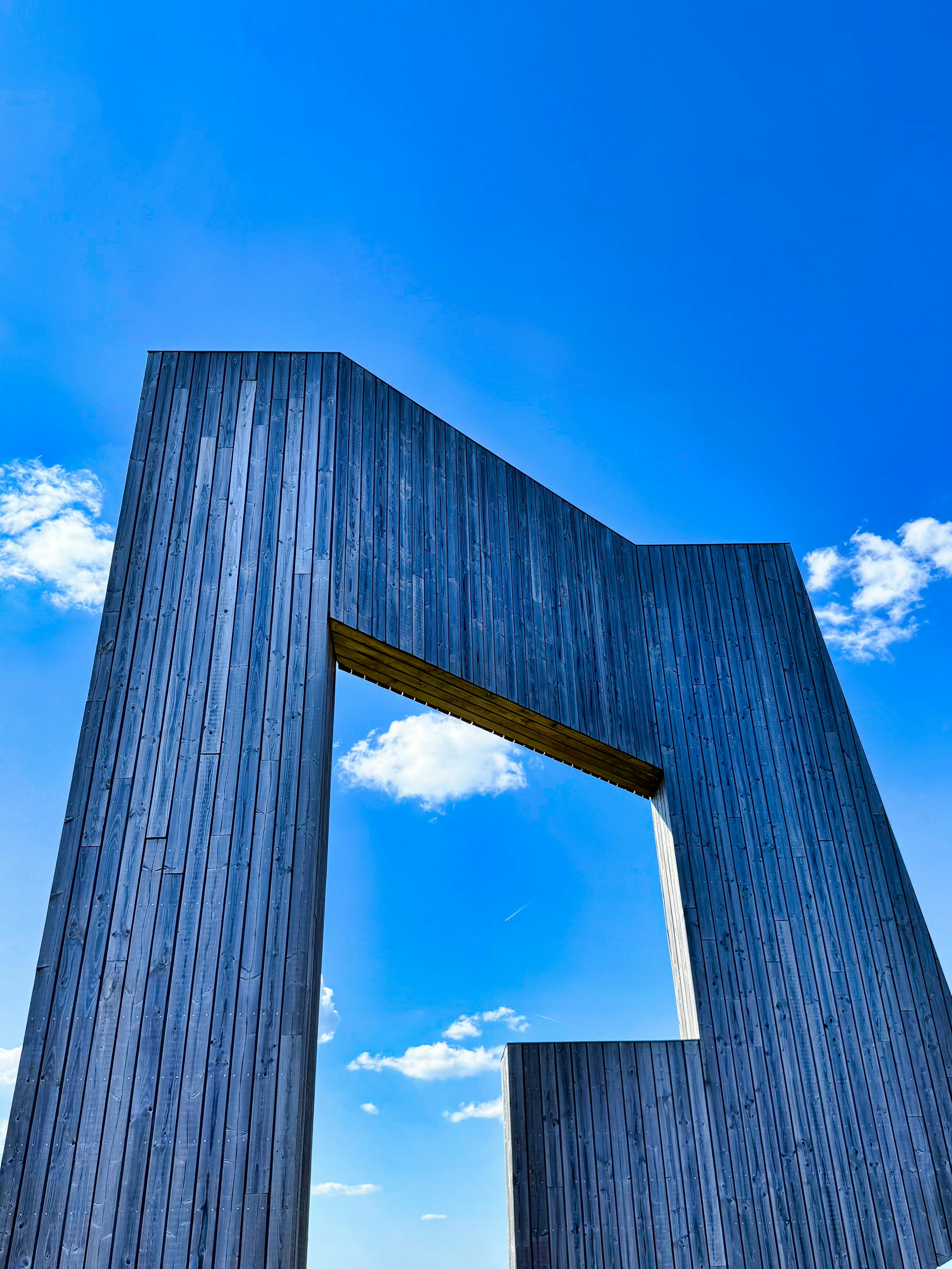 Modern Wooden Structure Against Blue Sky · Free Stock Photo