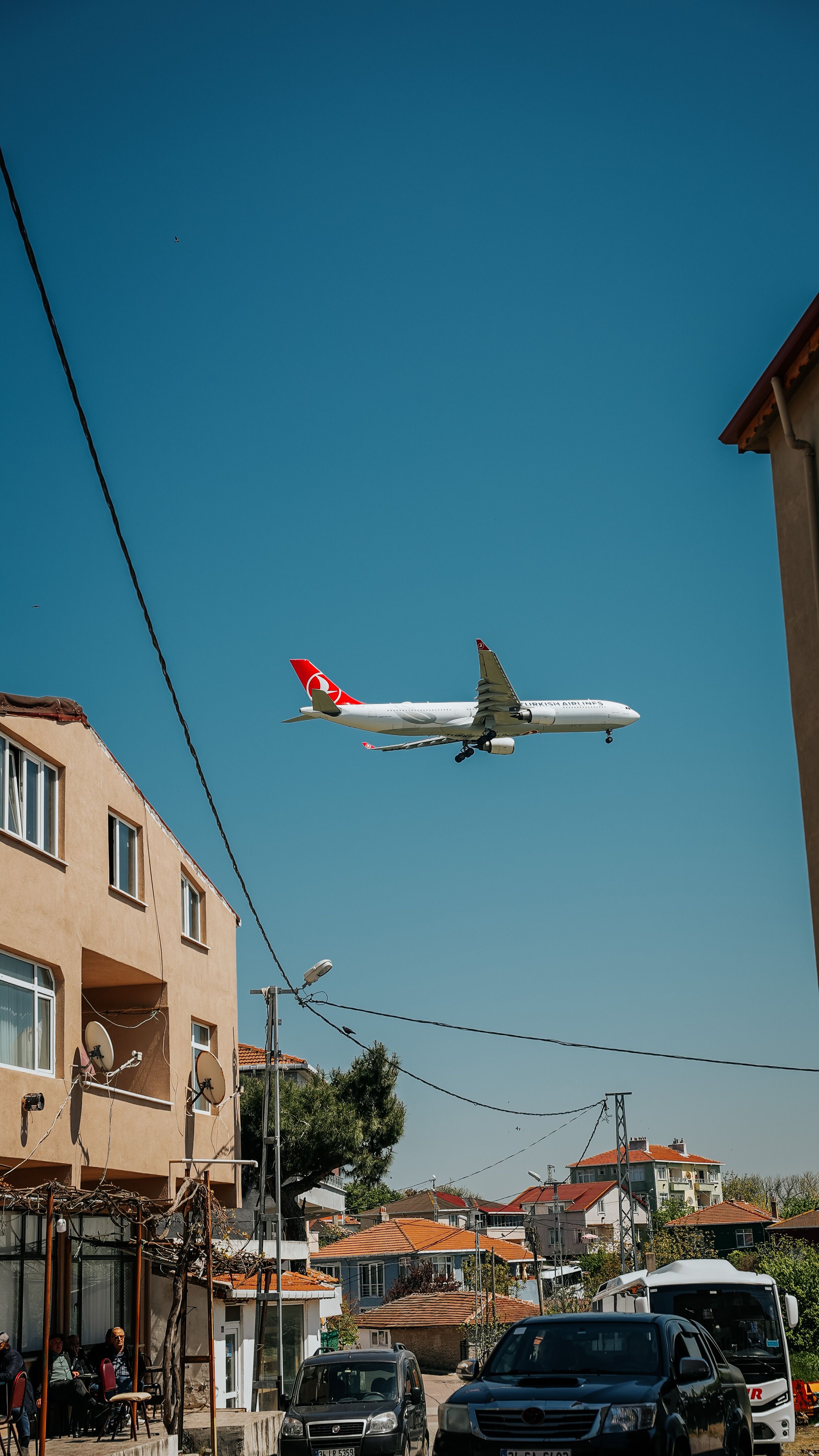 Airplane Flying Over Residential Neighborhood Street · Free Stock Photo