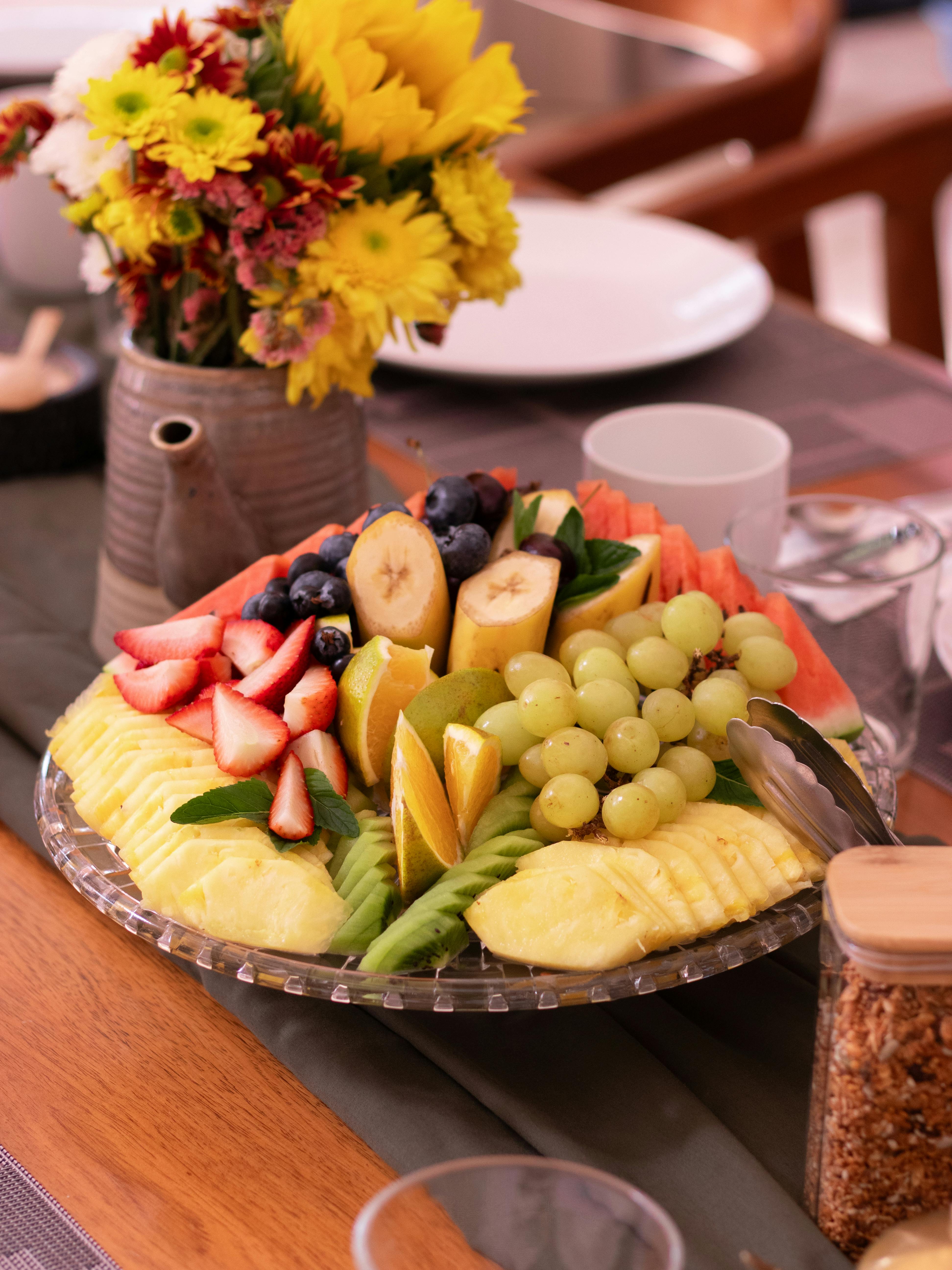 Colorful Fruit Platter with Flowers on Table · Free Stock Photo