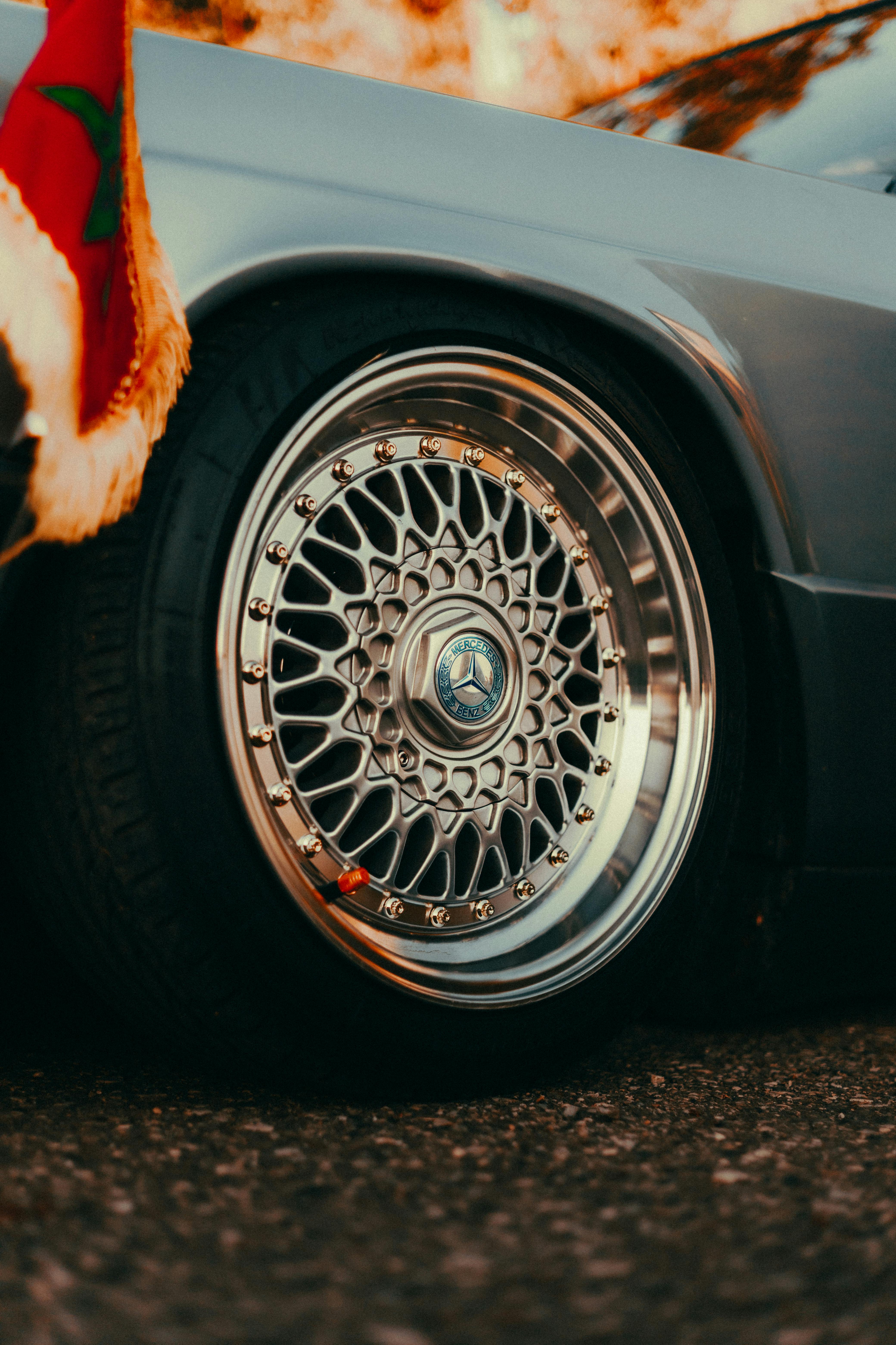 Close-up of Vintage Car Wheel with Chrome Rims · Free Stock Photo