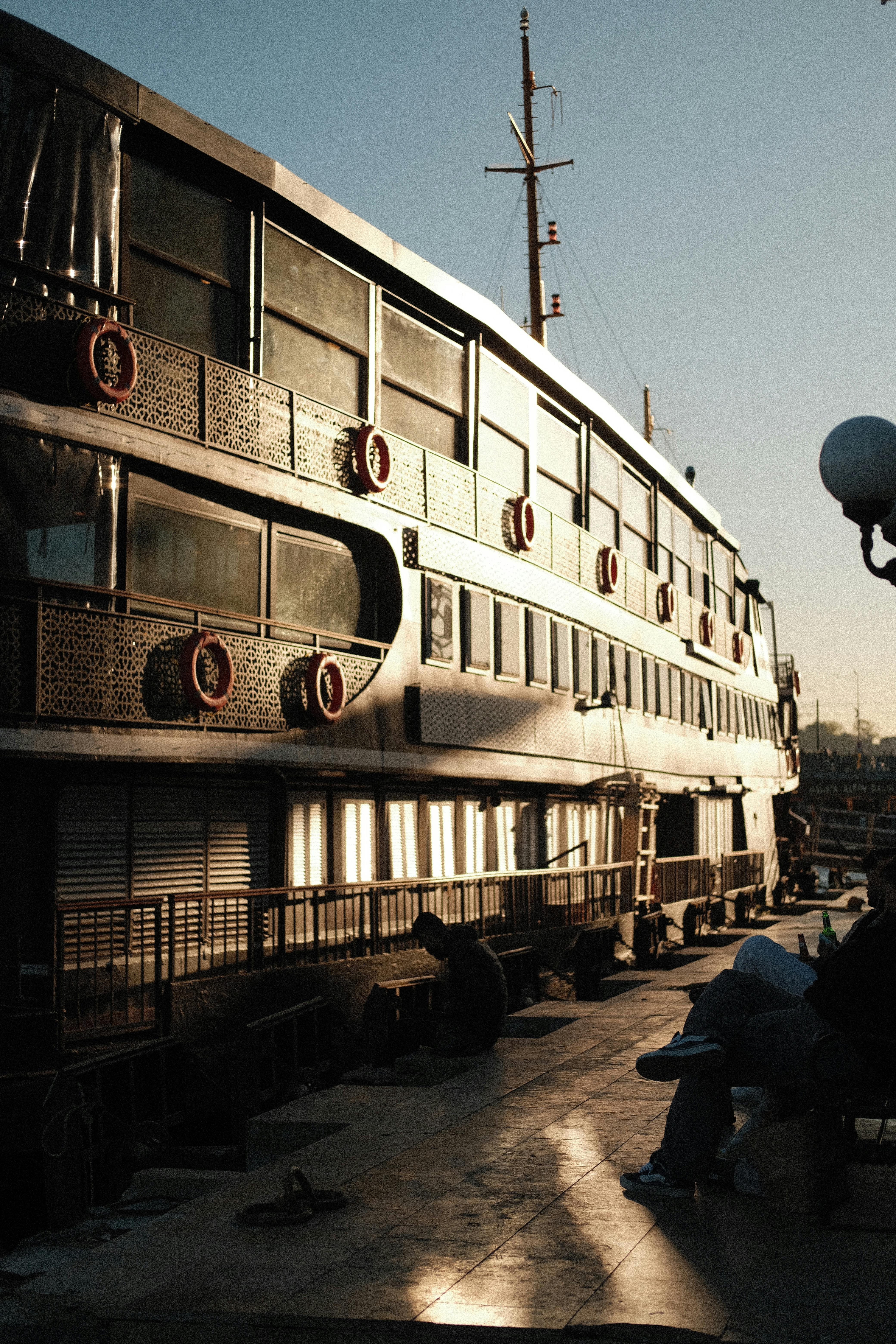 Sunlit Old Ship Docked at Waterfront · Free Stock Photo