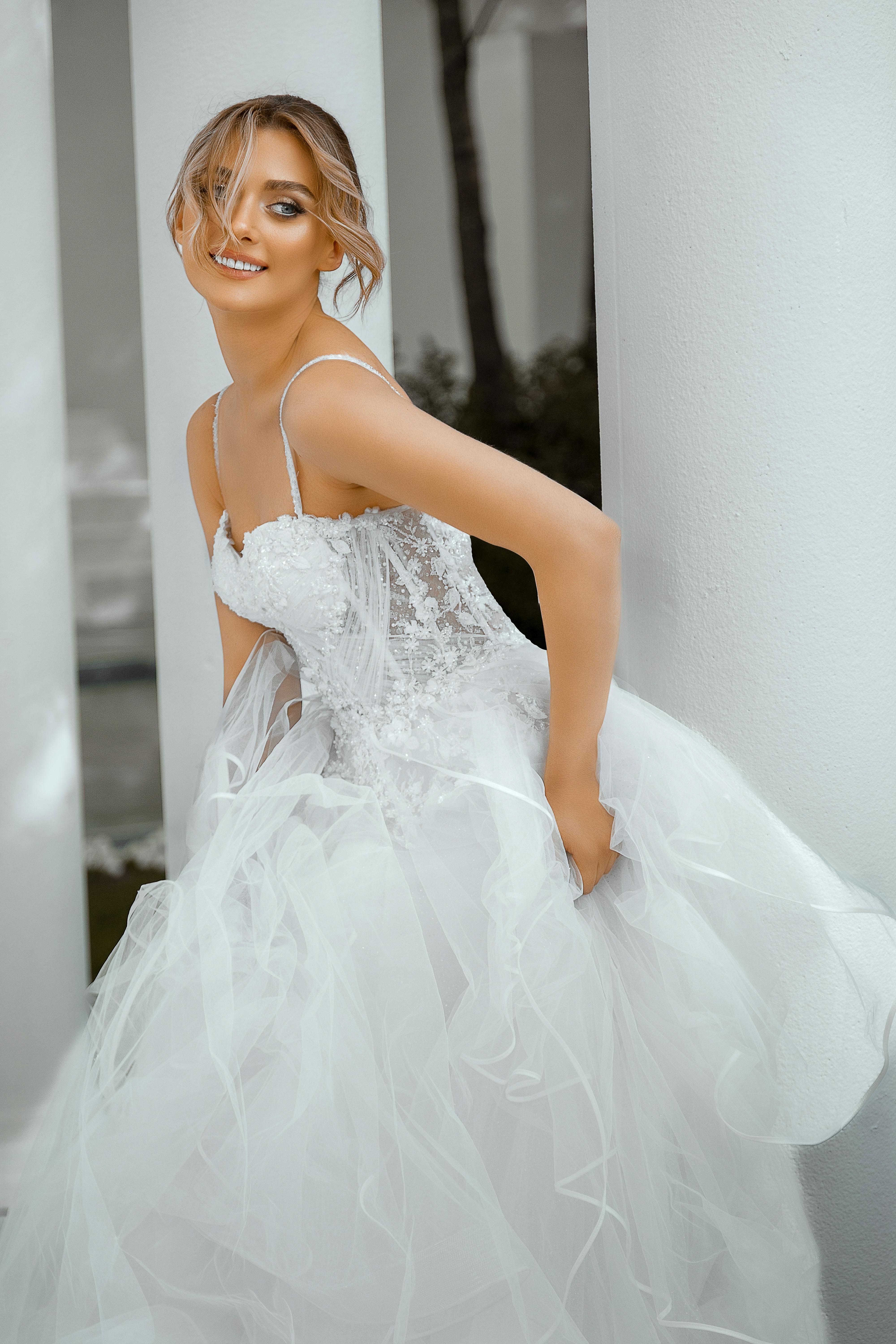 Elegant Bride in a Flowing Lace Wedding Gown · Free Stock Photo