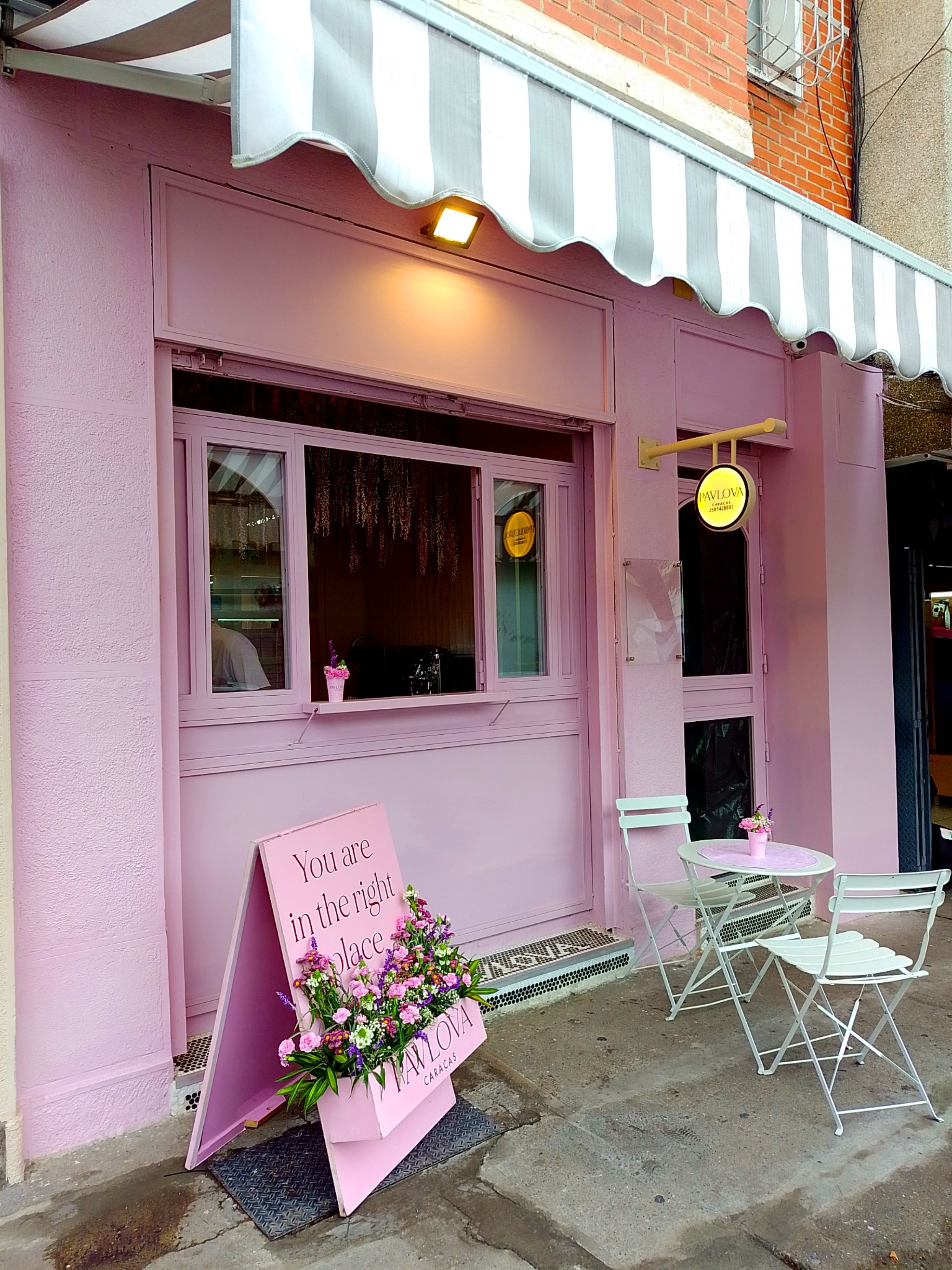 Charming Pink Café Exterior with Floral Decor · Free Stock Photo