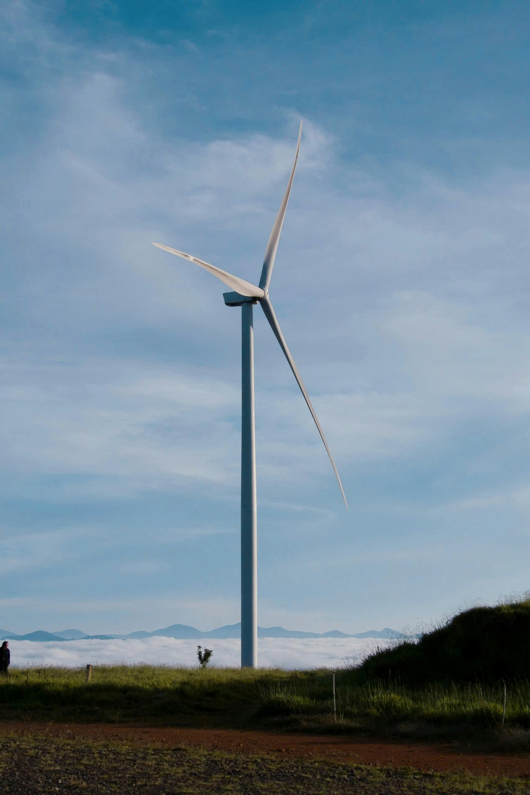 Majestic Wind Turbine in Open Field Landscape · Free Stock Photo