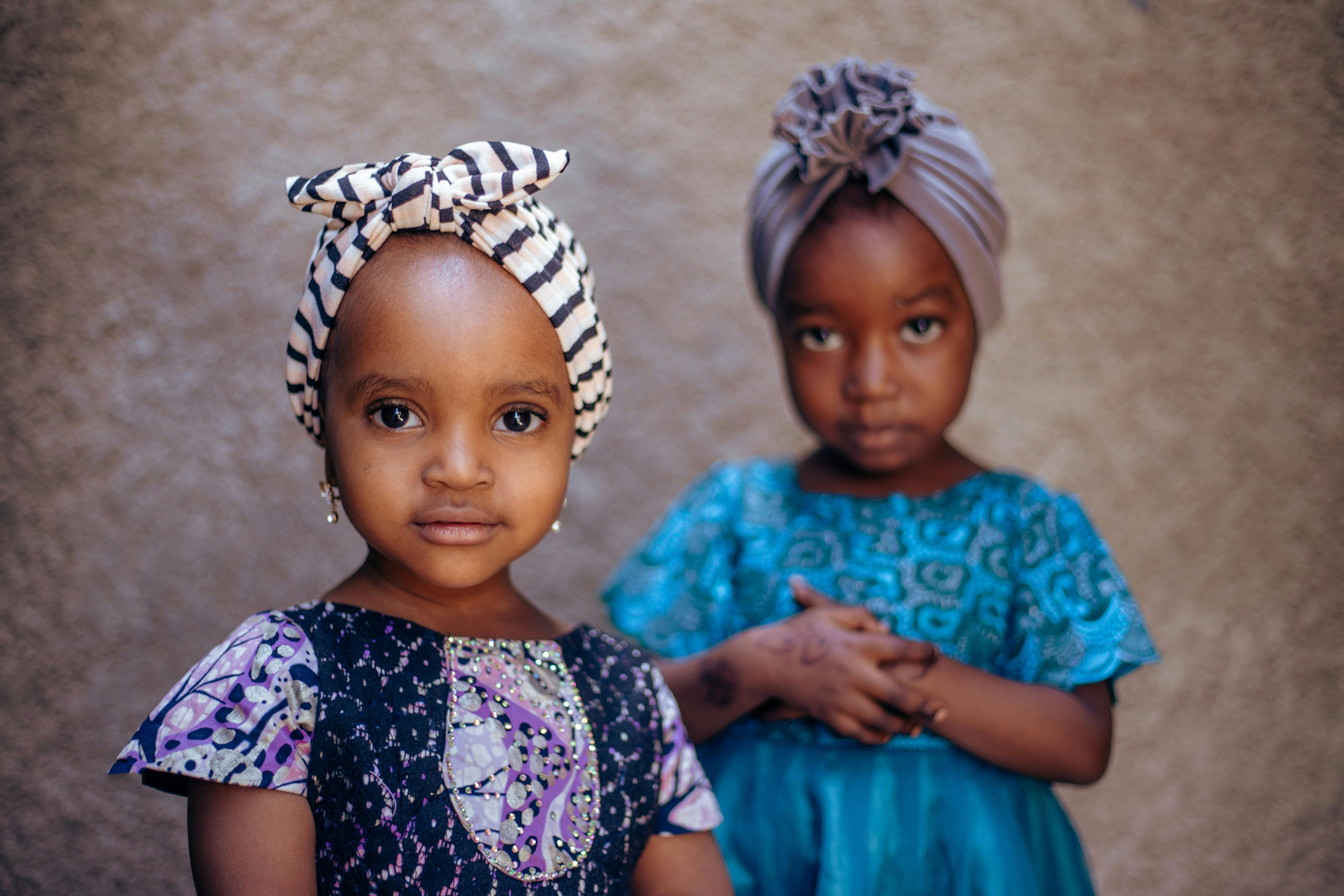Charming Portrait of Two Girls Wearing Colorful Headwraps · Free Stock ...