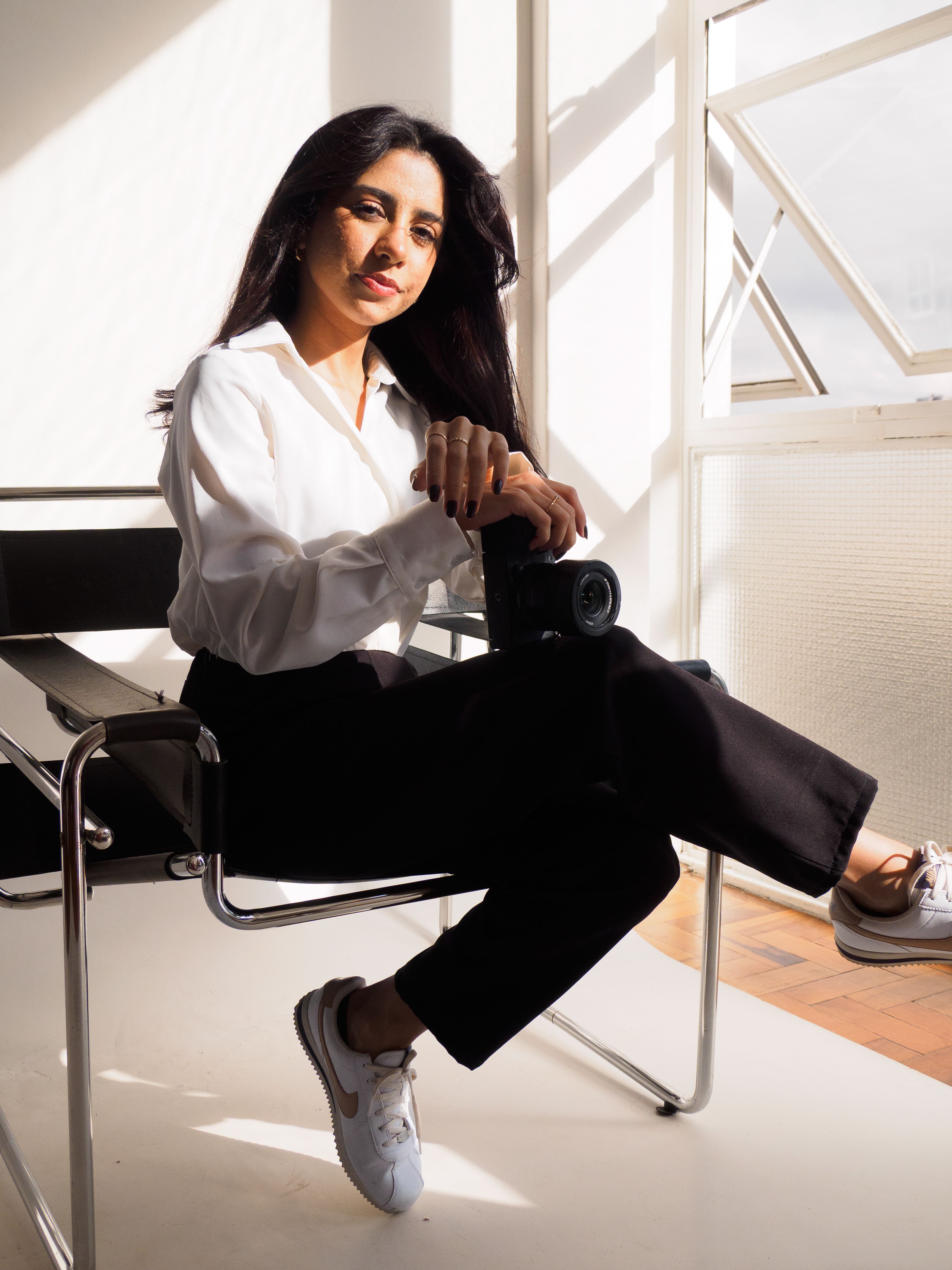 Professional Photographer Seated with Camera in Sunlit Room · Free ...