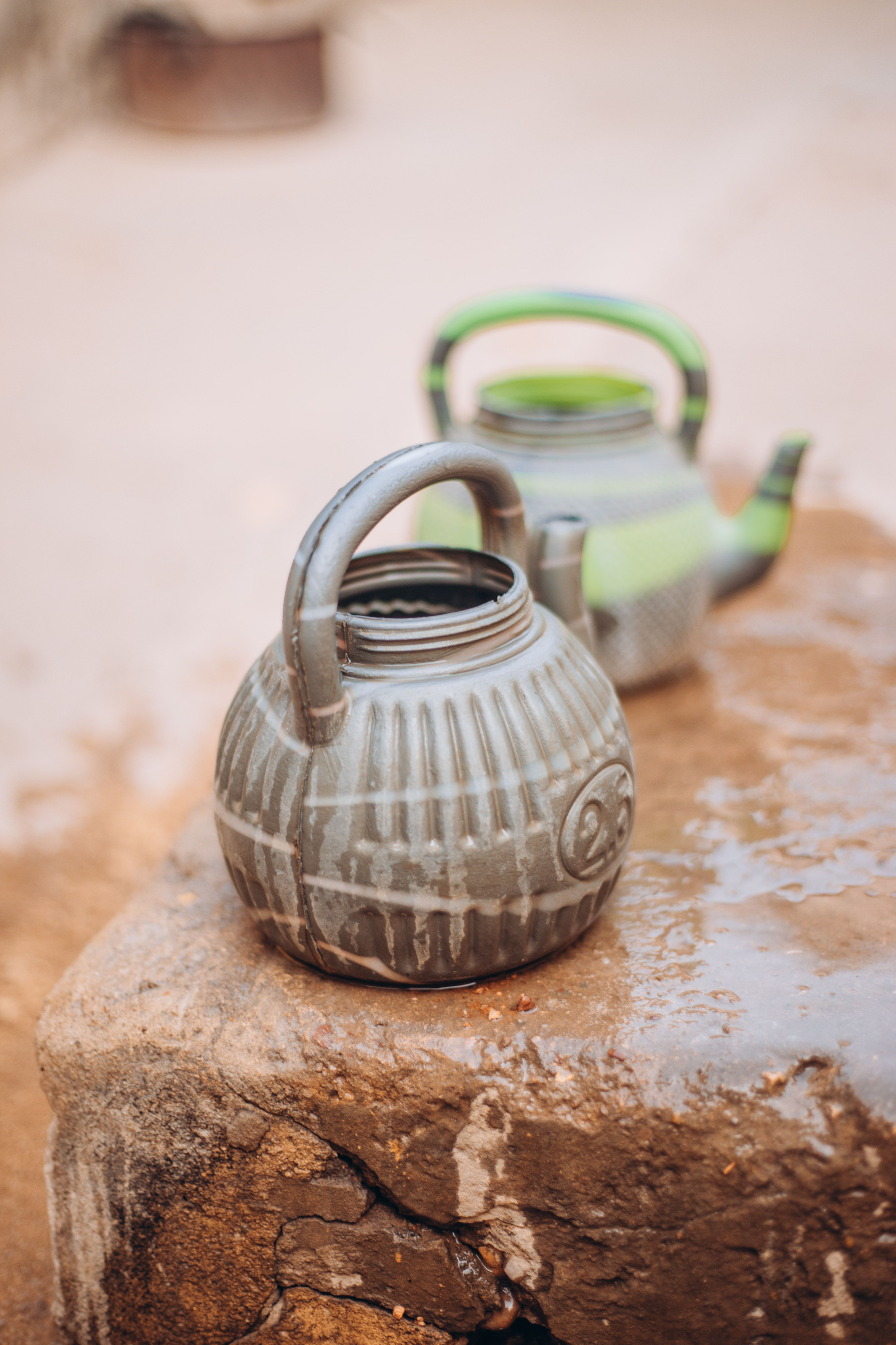 Rustic Ceramic Teapots on Weathered Stone · Free Stock Photo