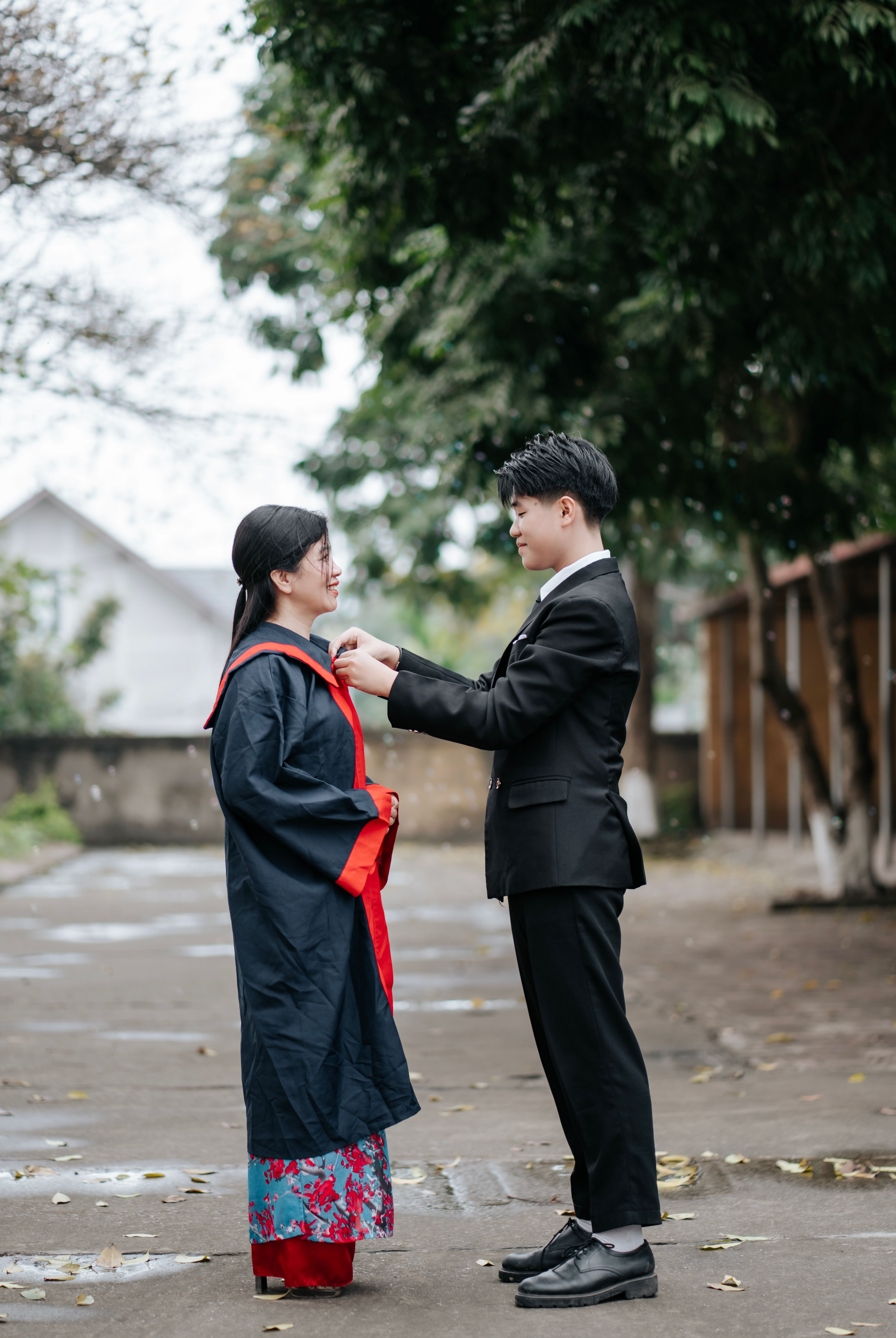 Graduation Celebration Outdoors in Traditional Attire · Free Stock Photo