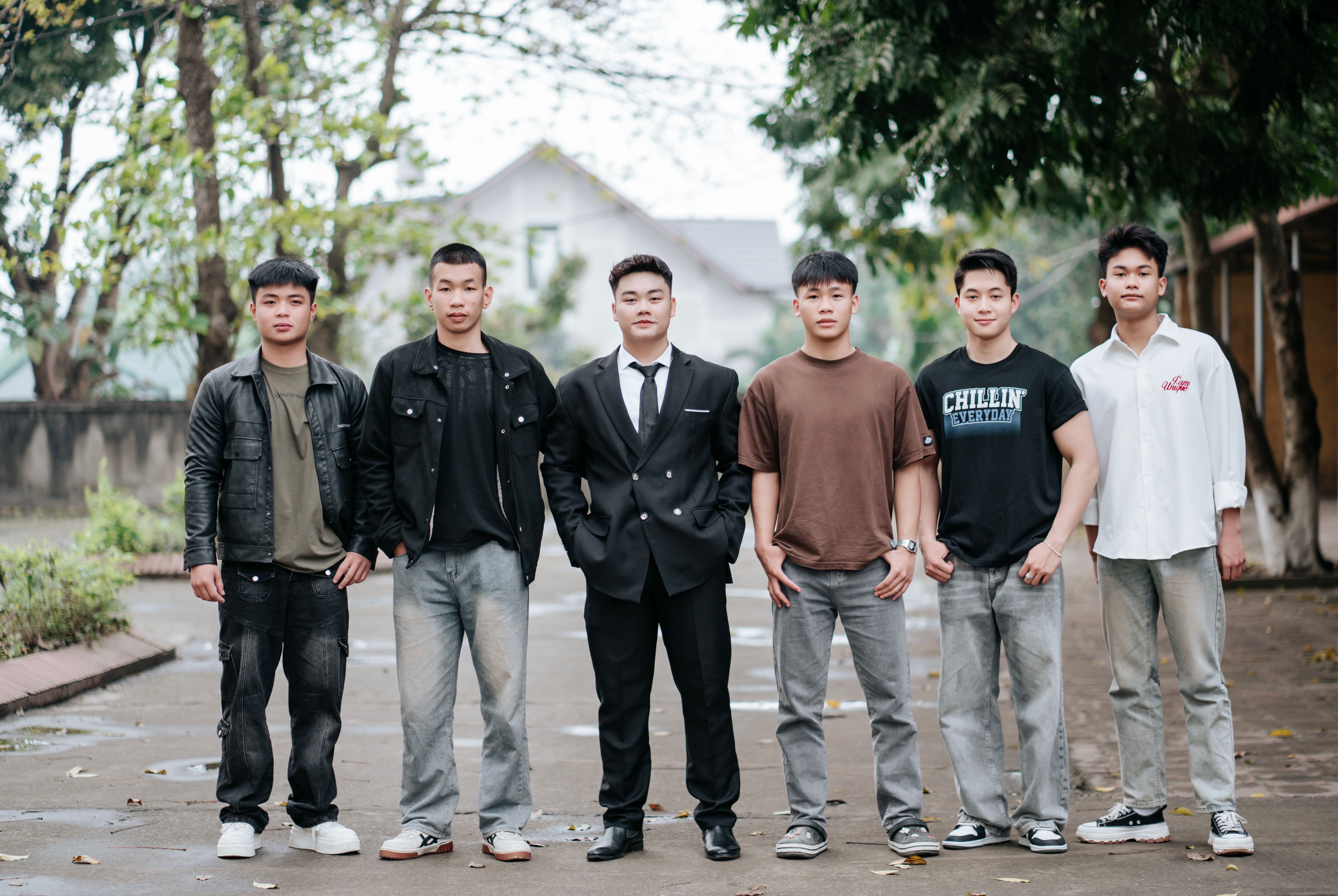 Group of Young Men Standing Outdoors Together · Free Stock Photo