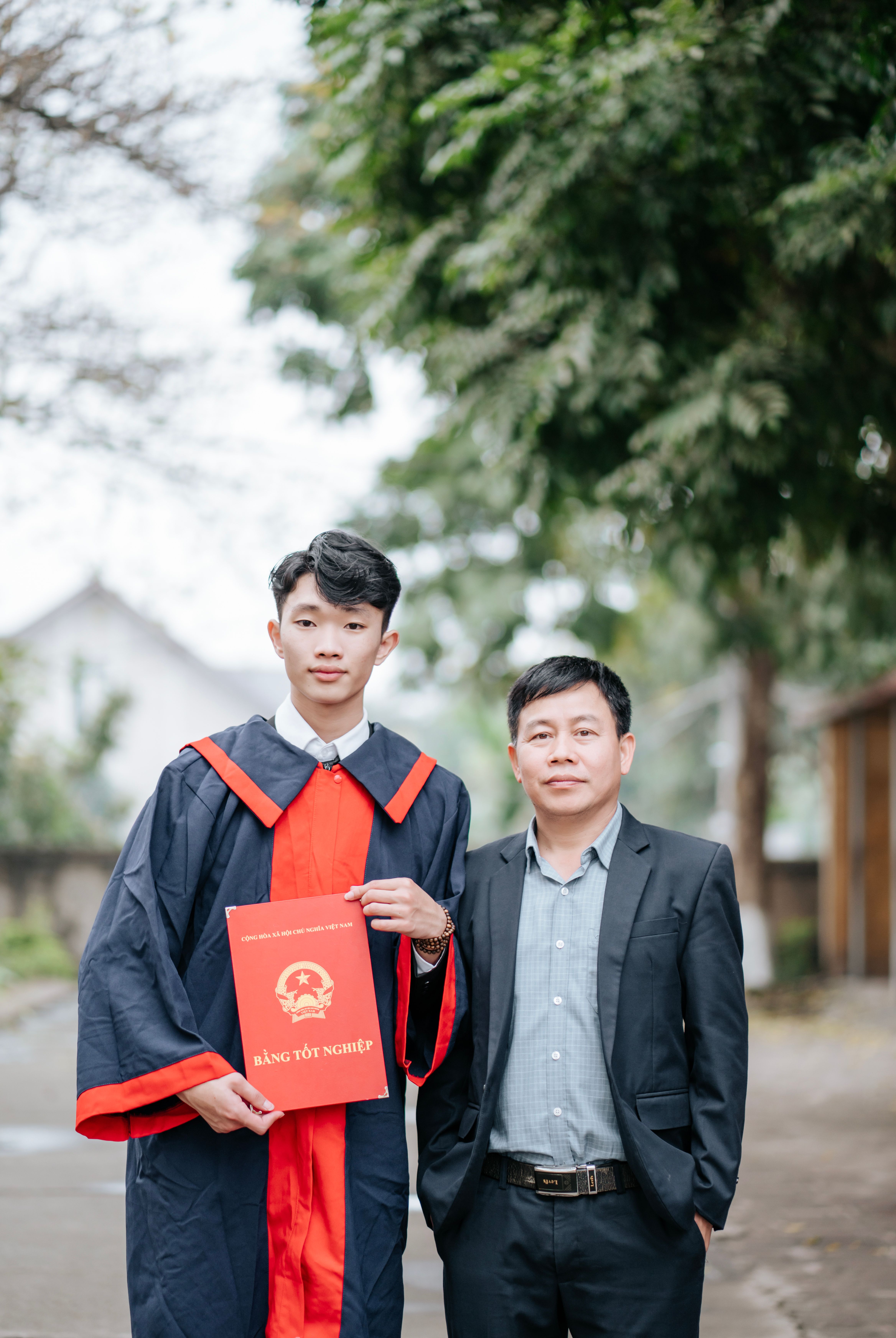 Graduation Celebration Outdoors with Certificate · Free Stock Photo