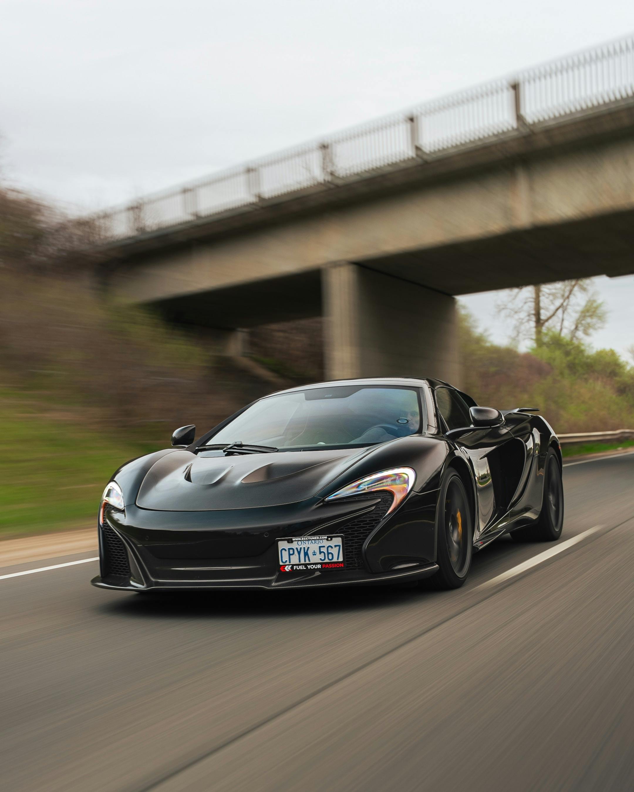 Sleek McLaren Supercar Speeding on Highway · Free Stock Photo
