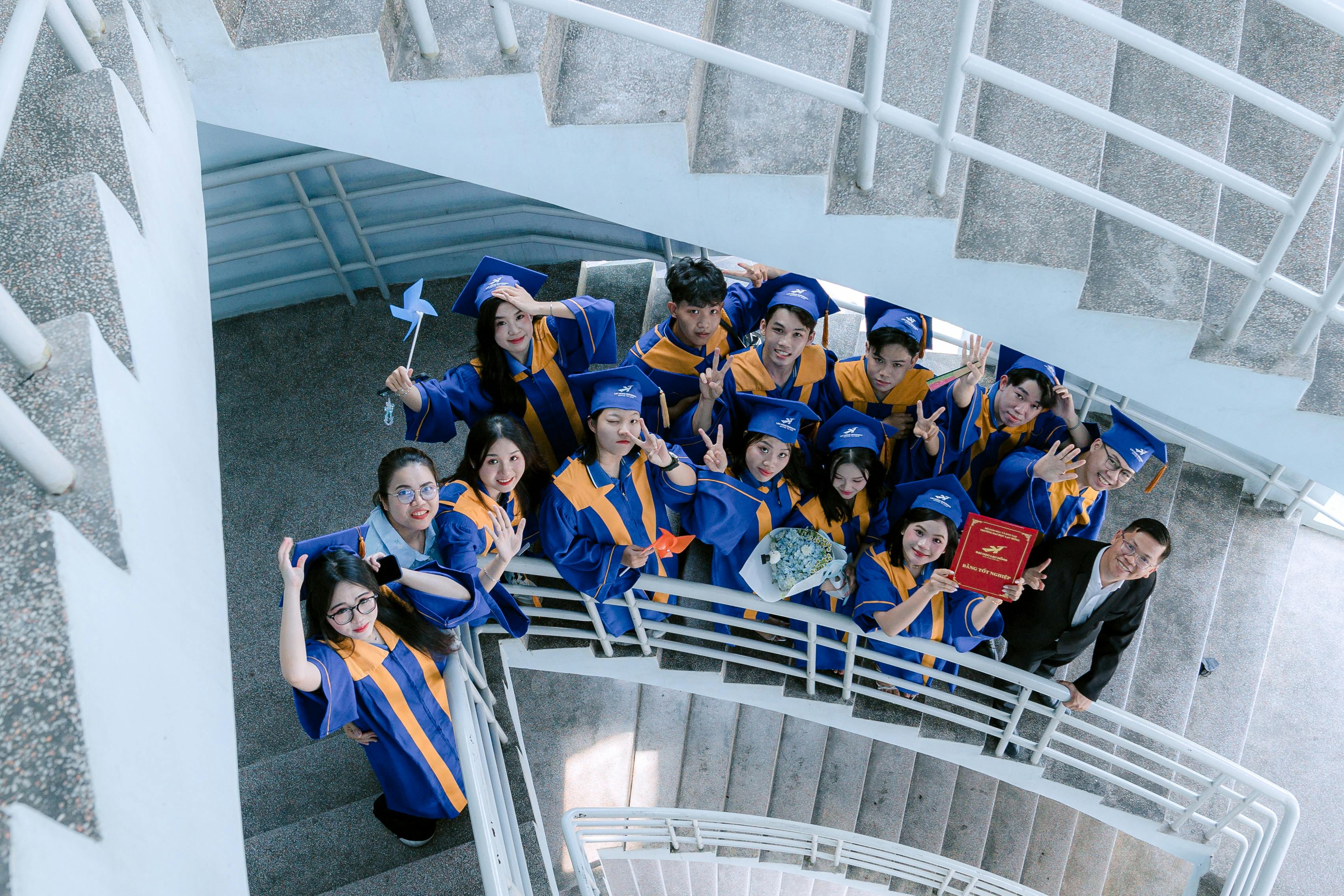 Graduation Ceremony Group Photo on Spiral Staircase · Free Stock Photo