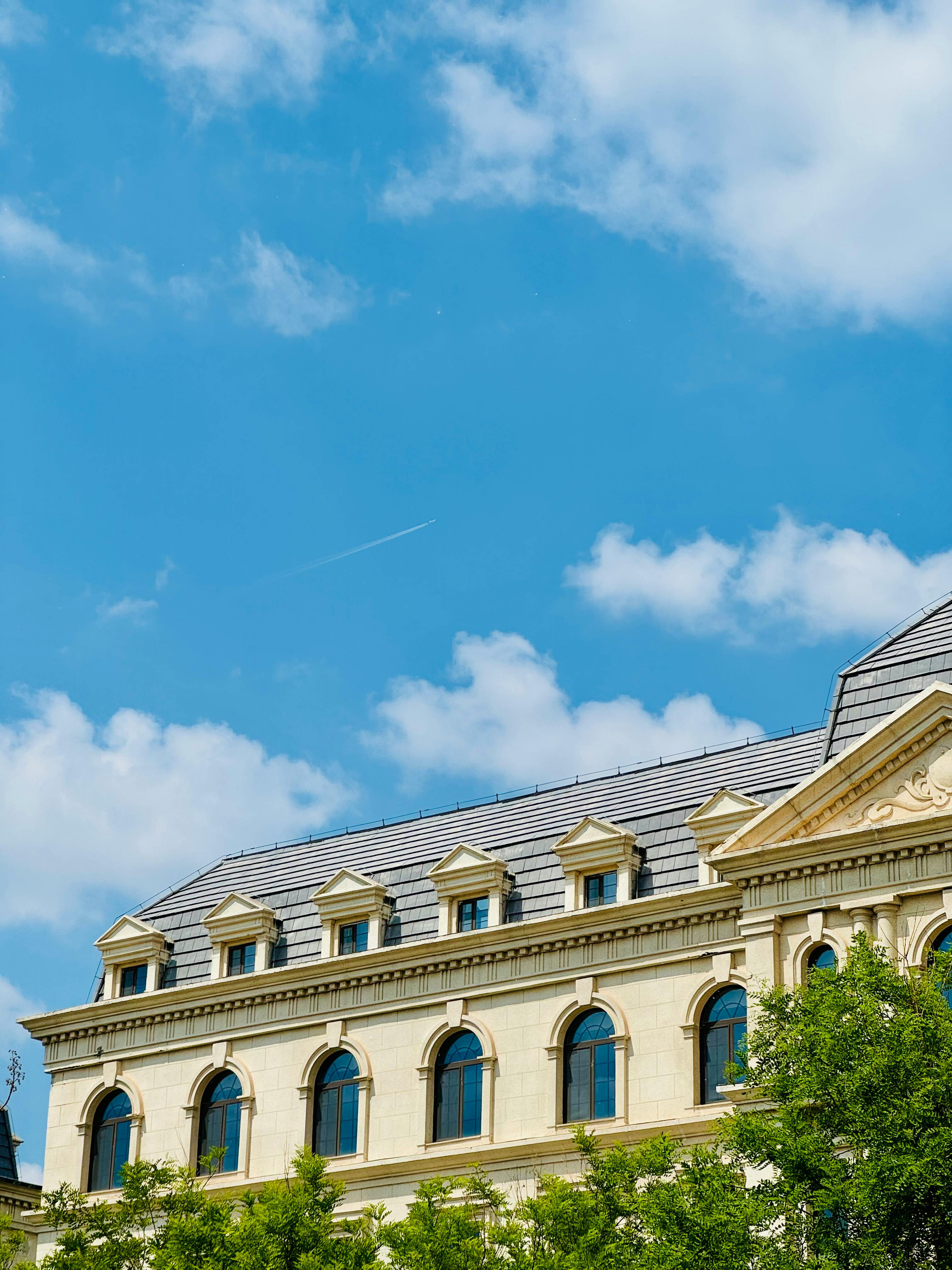 Elegant European-Style Architecture Against Blue Sky · Free Stock Photo