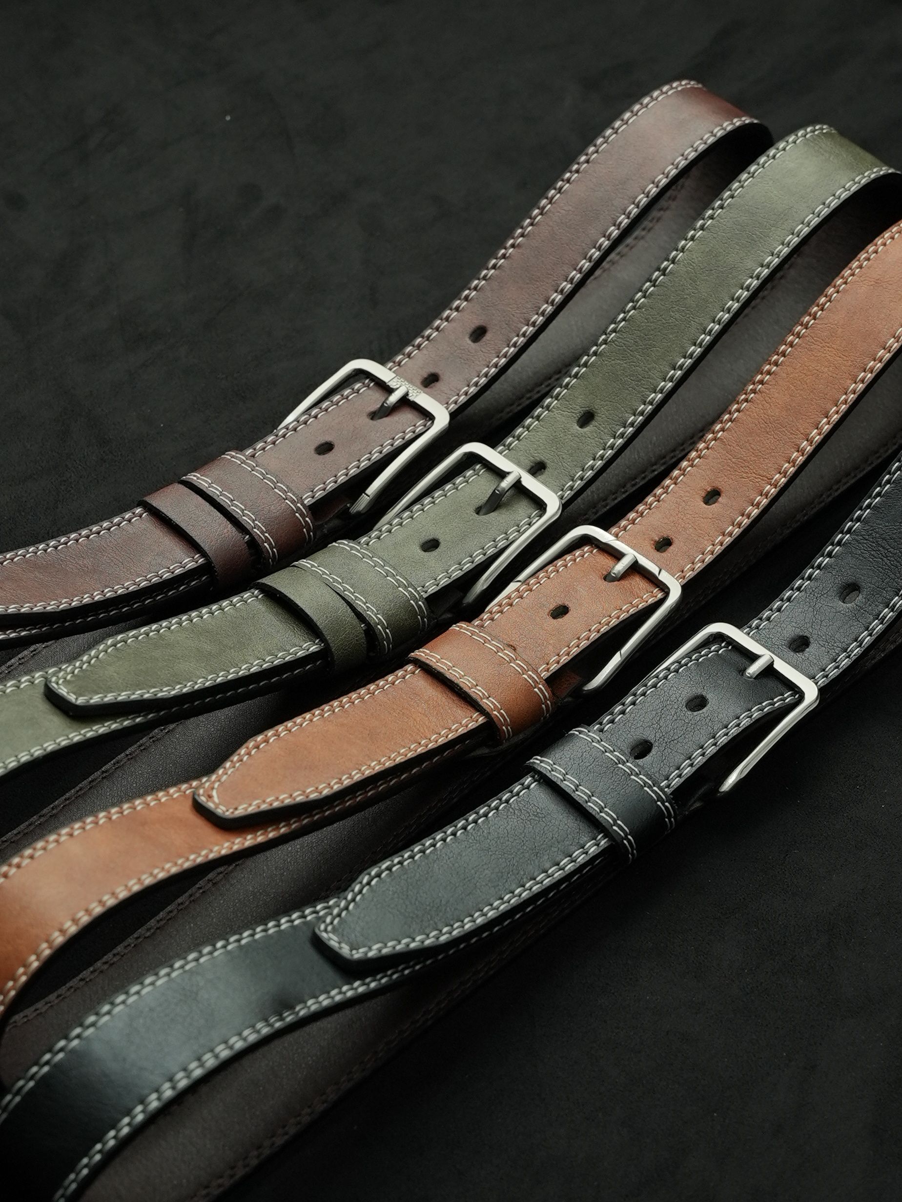 Variety of Leather Belts on Black Background · Free Stock Photo