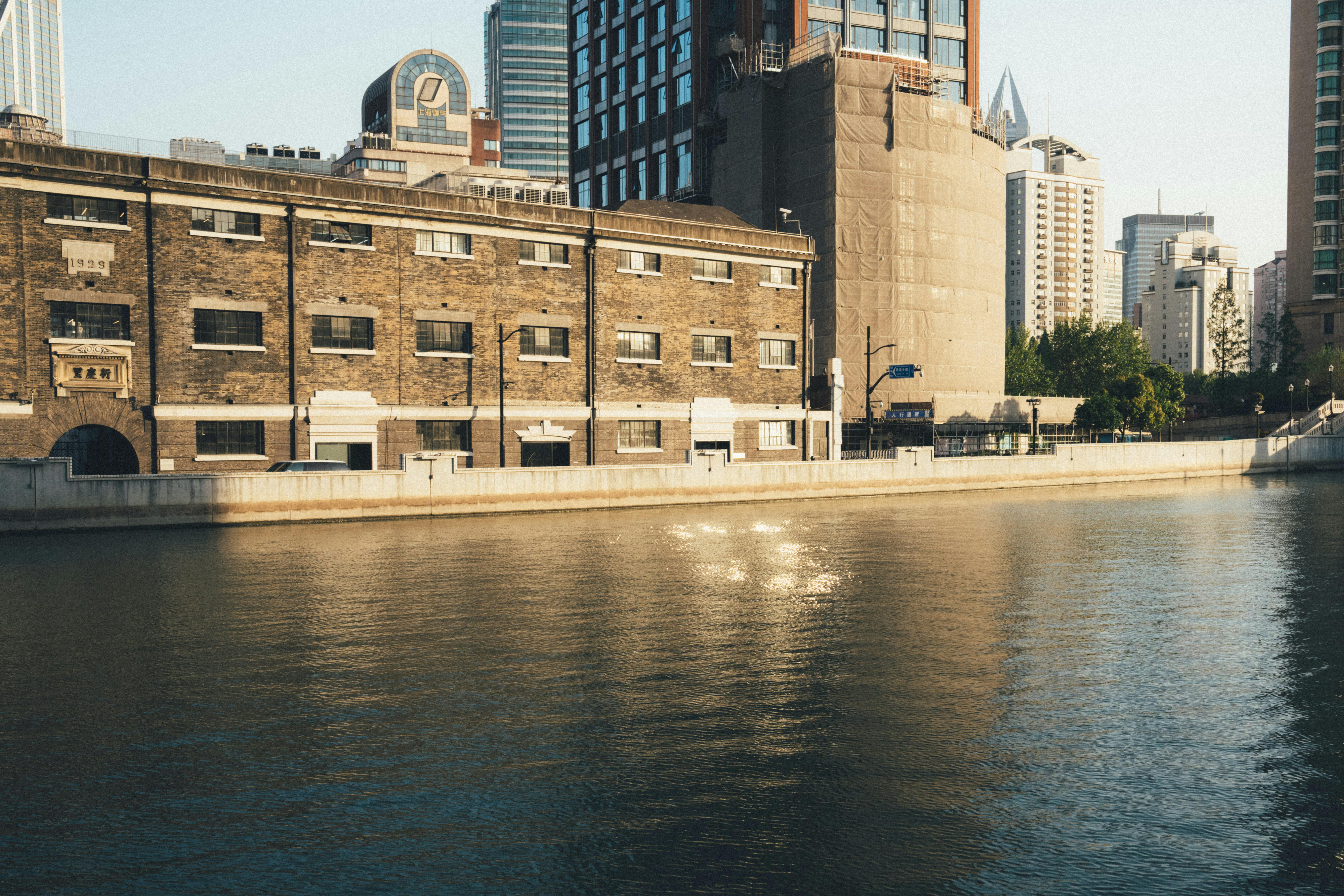 Urban Riverfront View with Historic Buildings · Free Stock Photo
