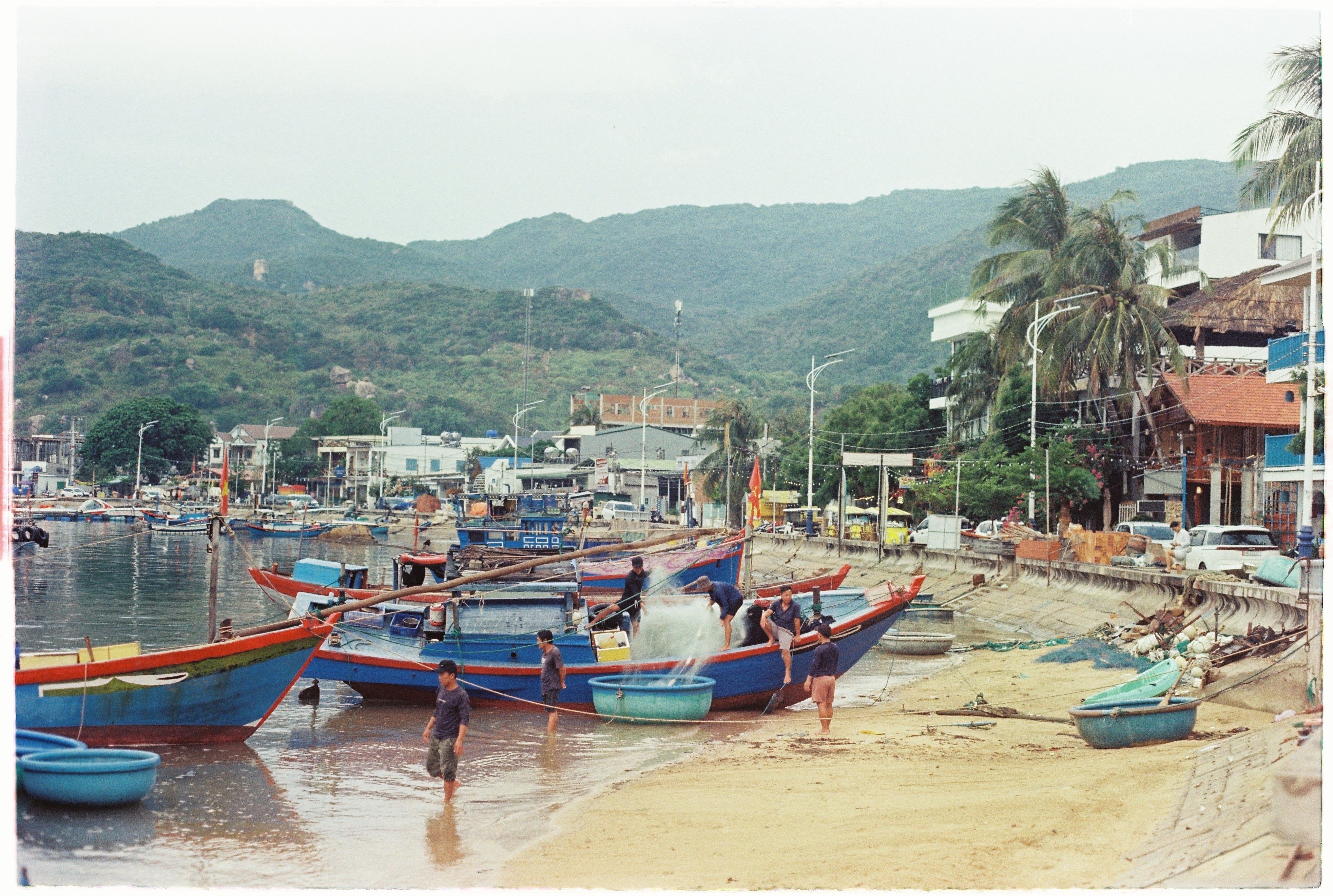 Colorful Fishing Boats at Beachfront Village Harbor · Free Stock Photo