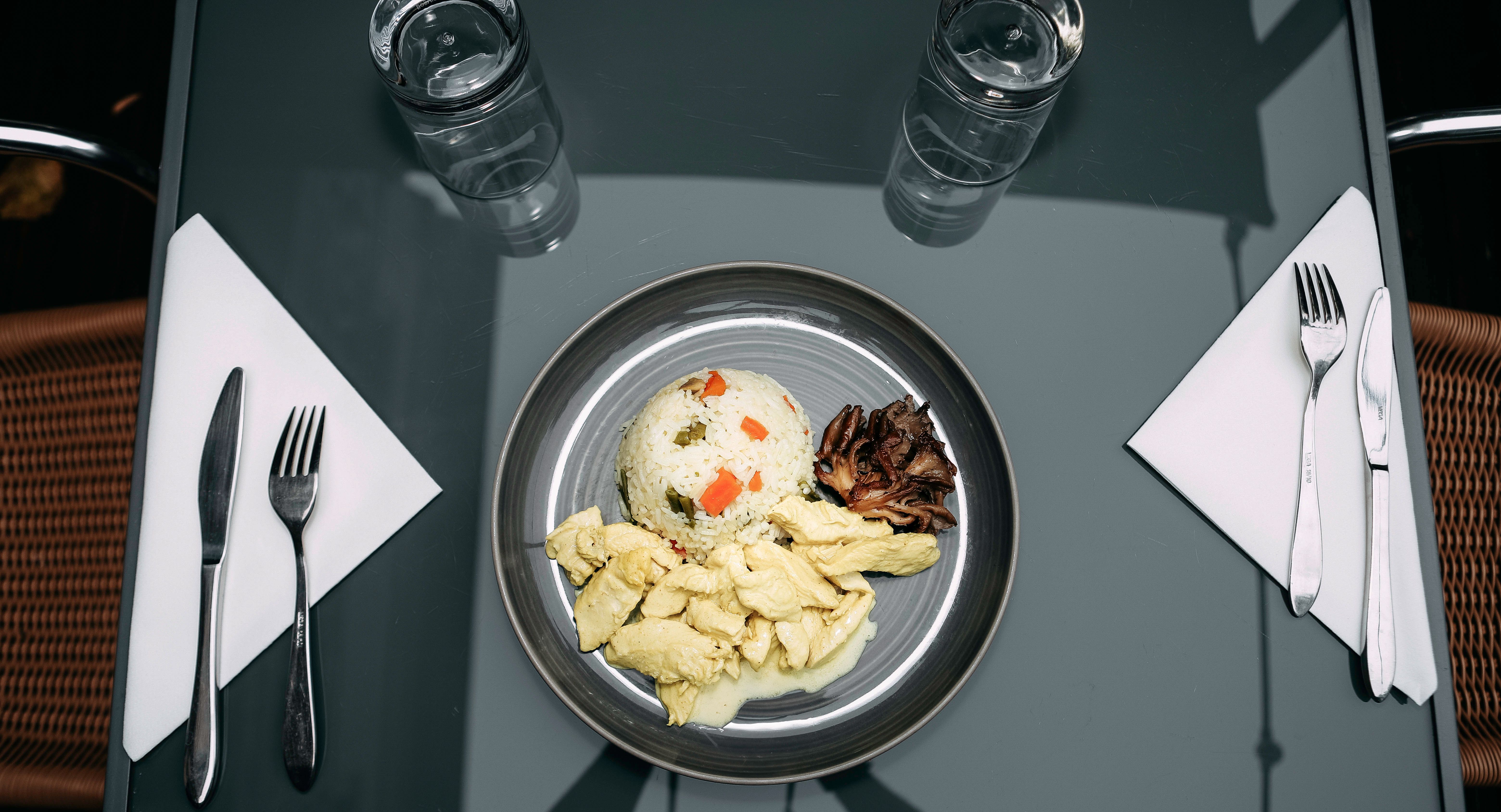 Delicious Chicken and Rice Meal on Table · Free Stock Photo