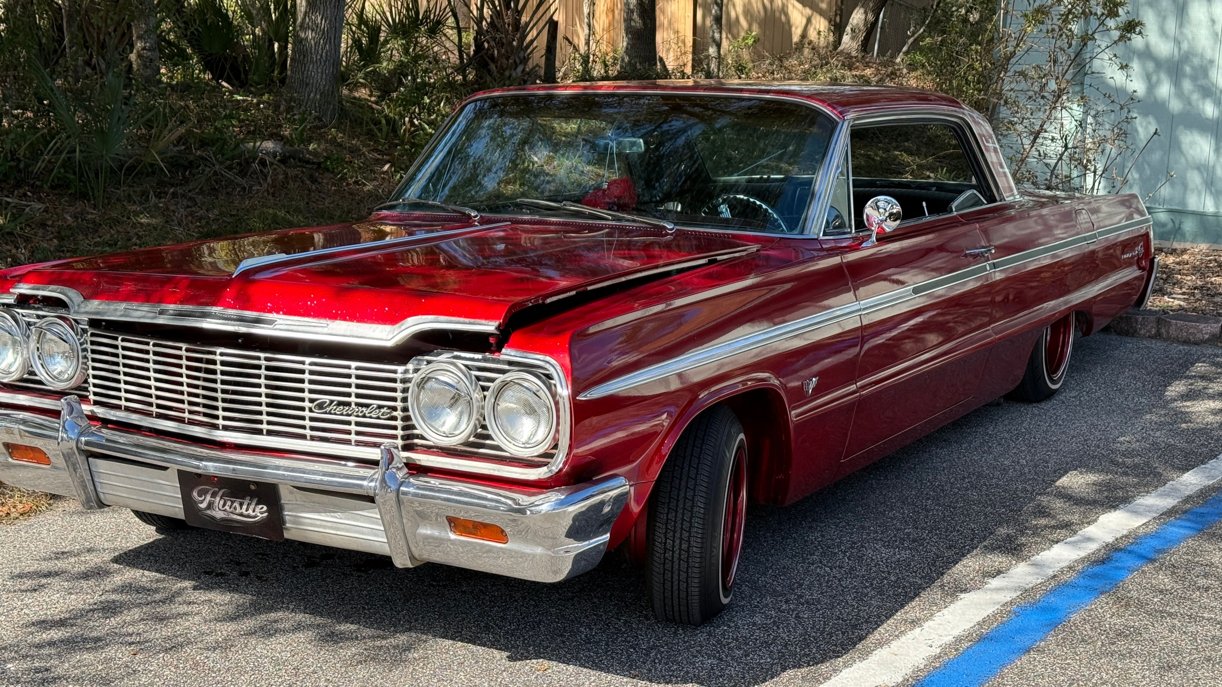 Classic Red Chevrolet Impala in Outdoor Setting · Free Stock Photo