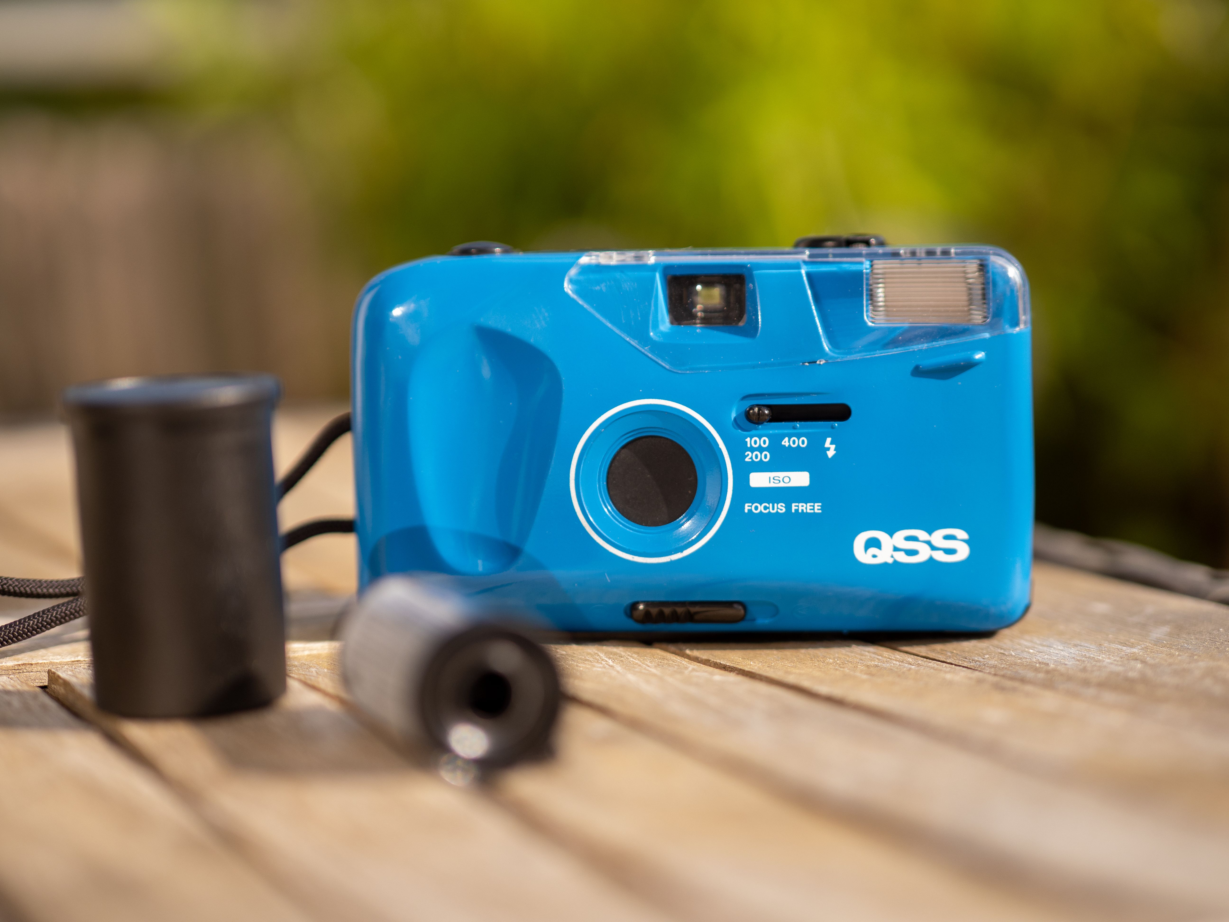 Vintage Blue Film Camera on Wooden Table Outdoors · Free Stock Photo