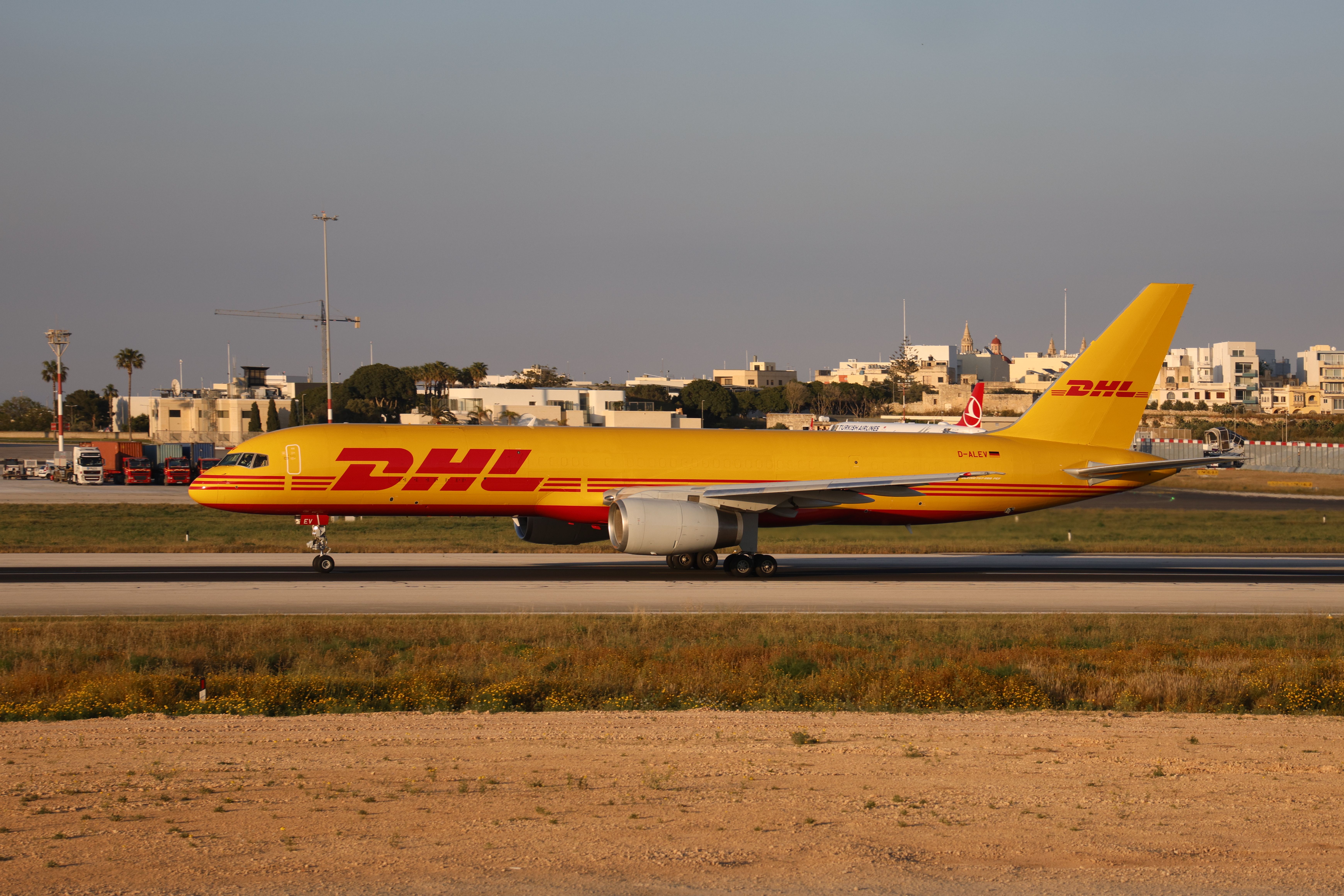 DHL Cargo Plane on Runway at Airport · Free Stock Photo
