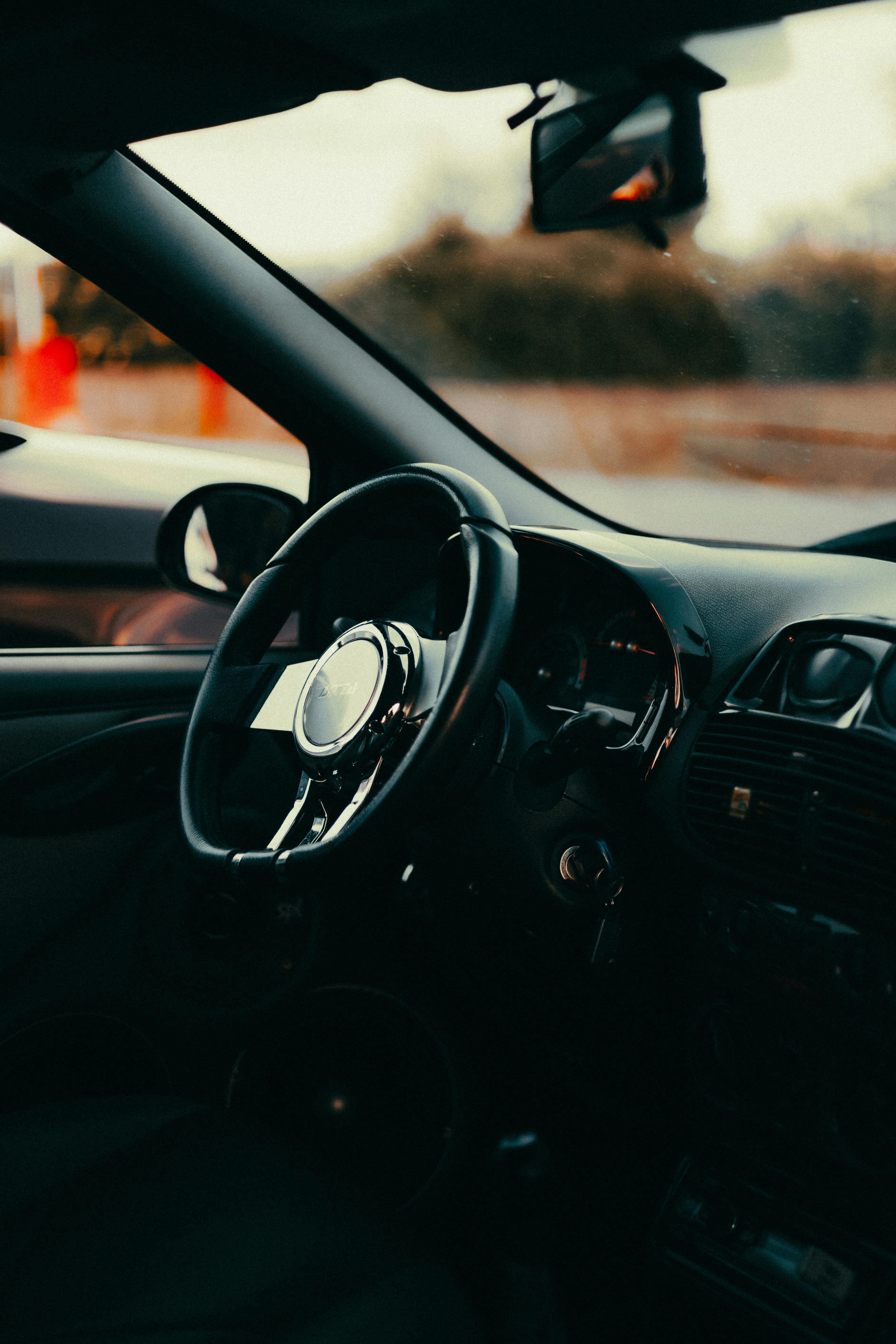 Moody Car Interior with Steering Wheel in Focus · Free Stock Photo