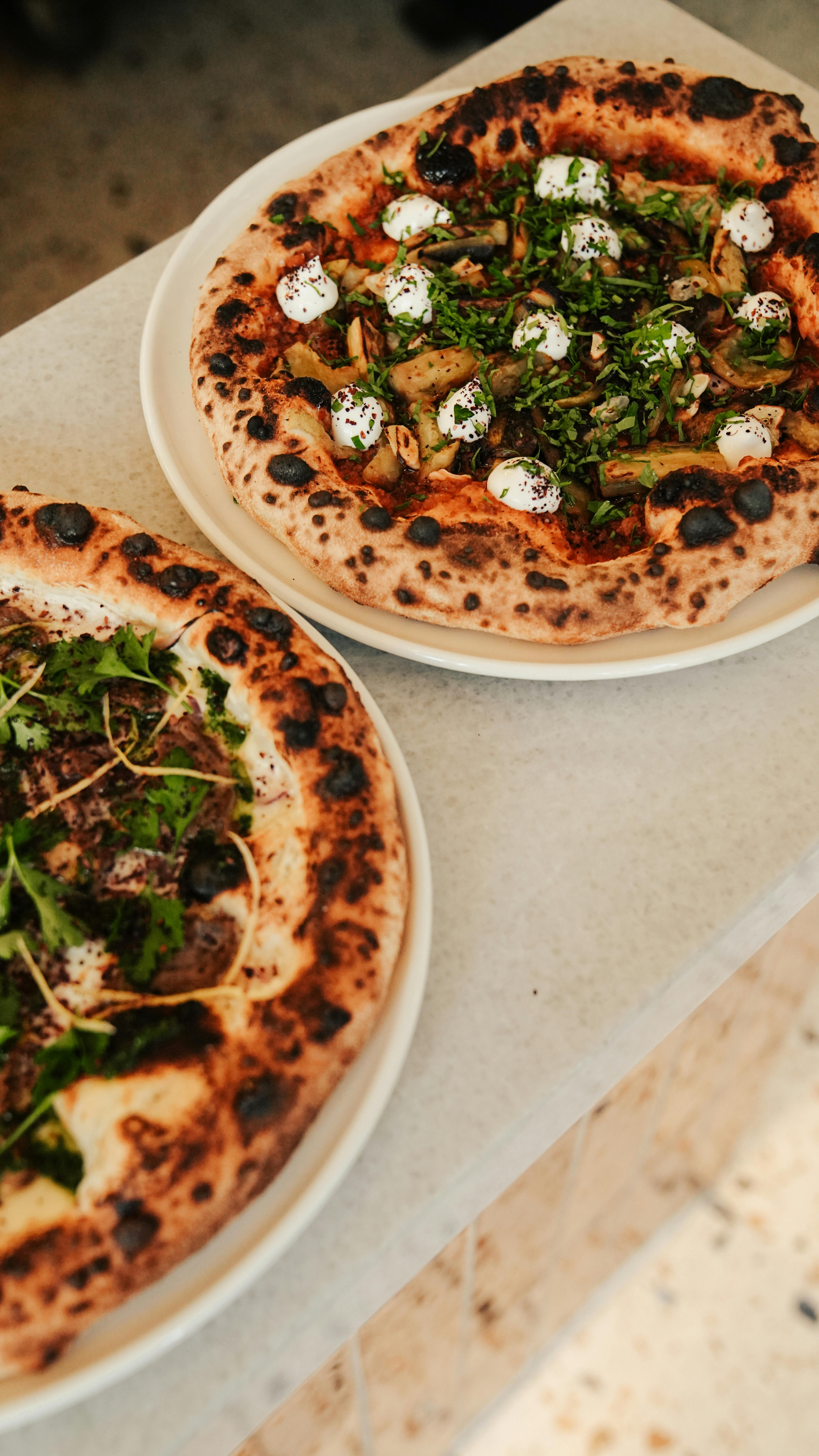 Rustic Artisan Pizzas with Fresh Toppings · Free Stock Photo