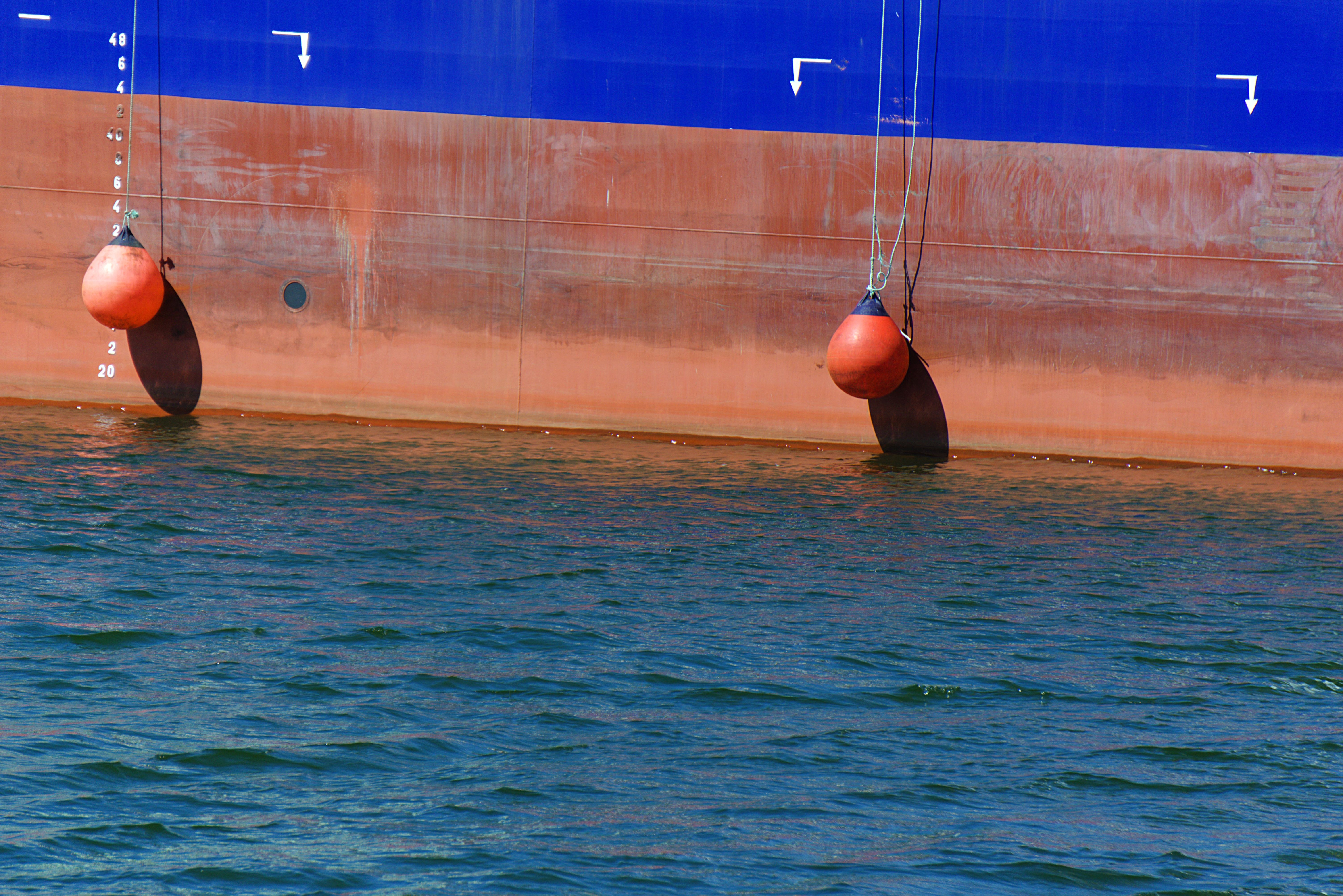 Large Ship with Red Mooring Buoys in Blue Waters · Free Stock Photo