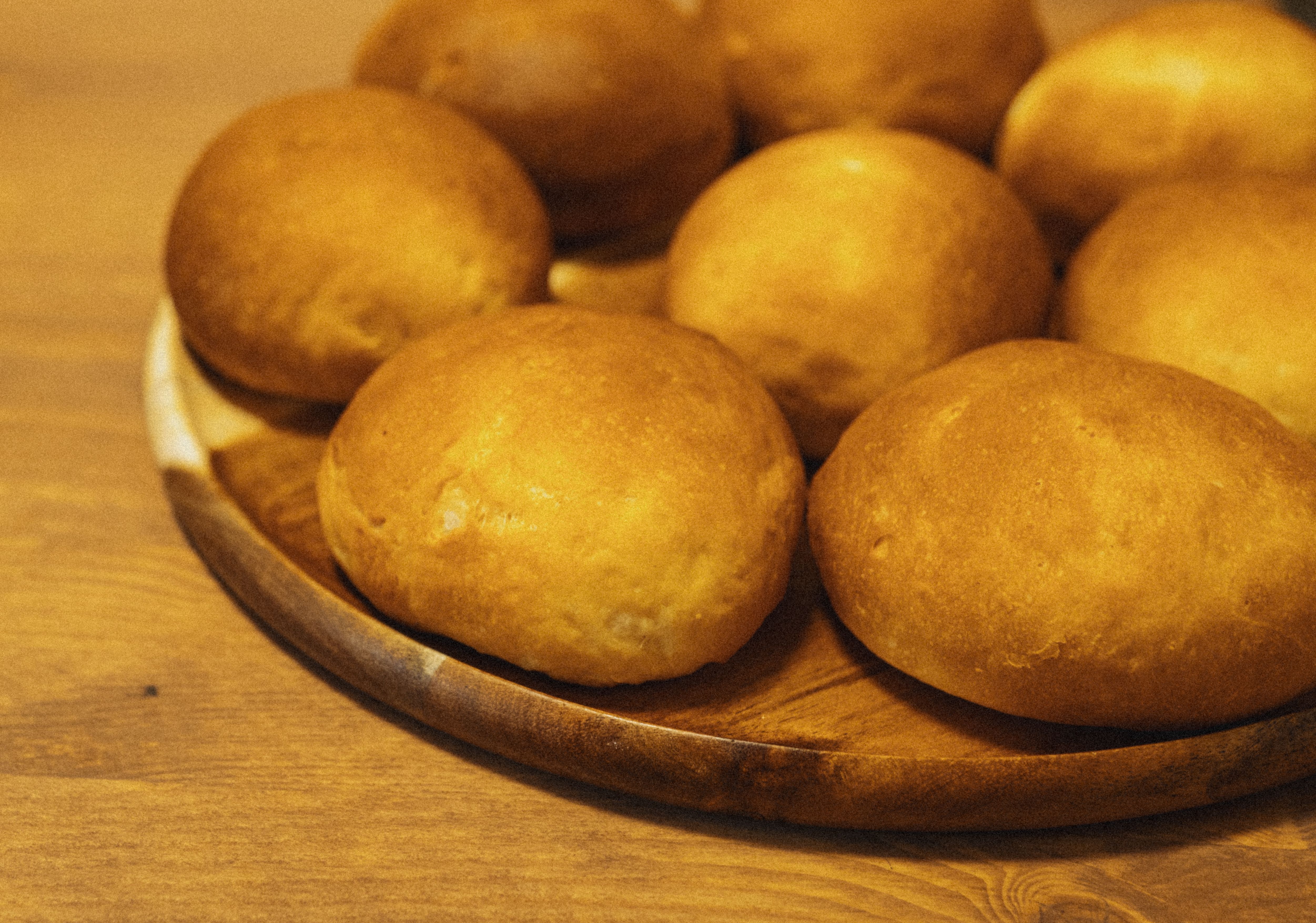 Freshly Baked Bread Rolls on Wooden Plate · Free Stock Photo