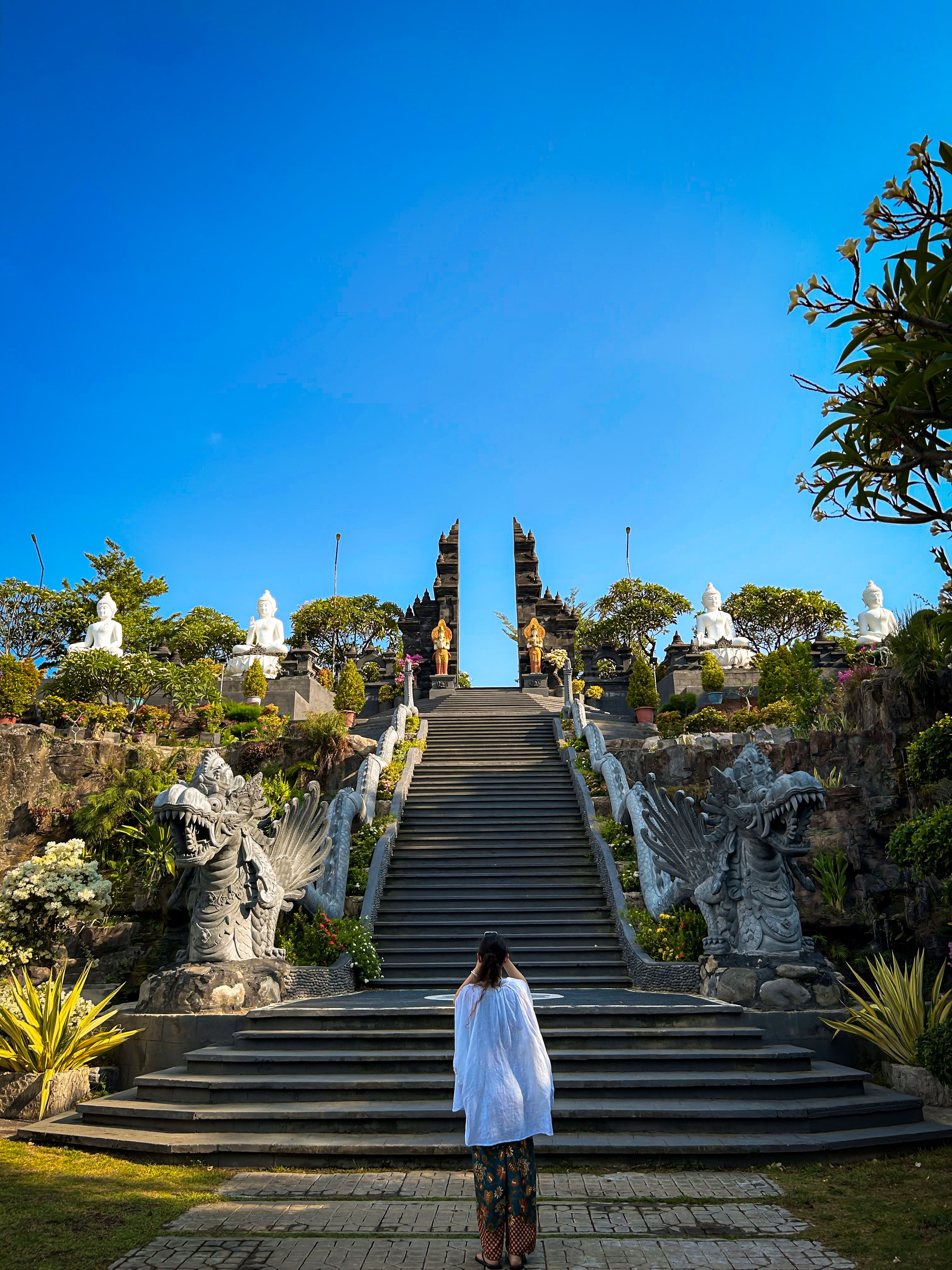 Woman Ascending Temple Stairs in Bali, Indonesia · Free Stock Photo