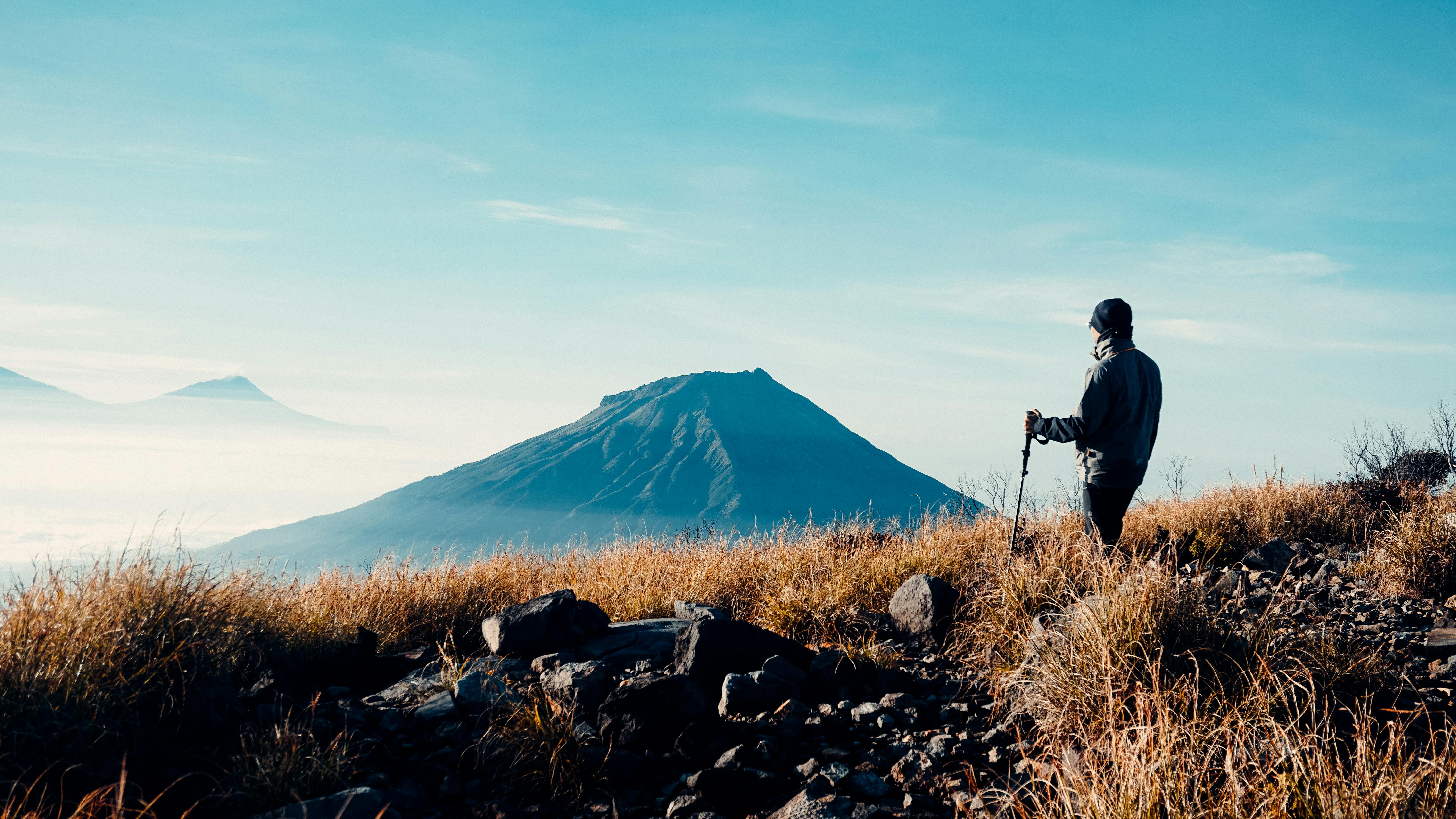 Hiker Admiring Mount Sindoro in Central Java · Free Stock Photo