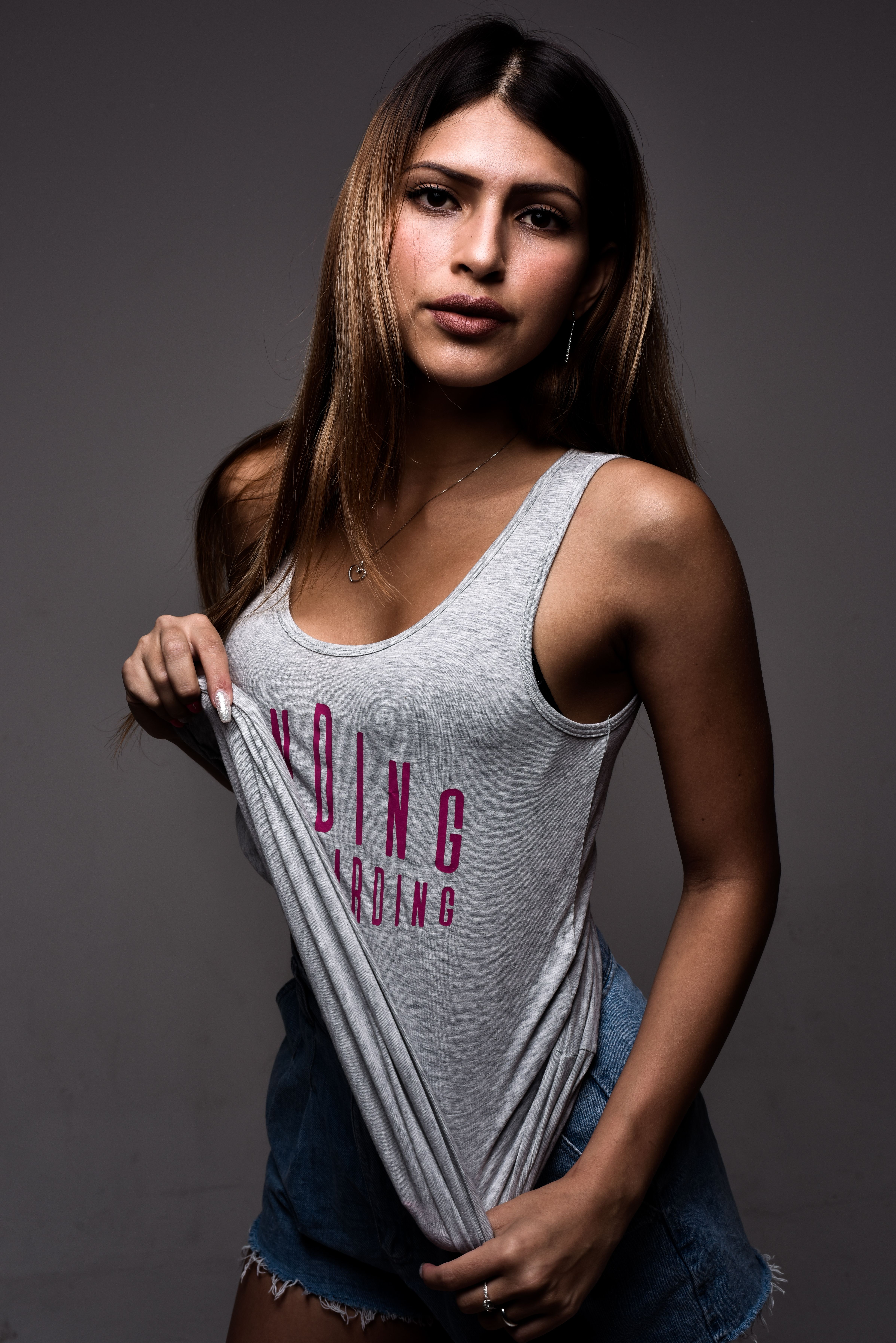 Woman in Casual Outfit Modeling in Studio · Free Stock Photo