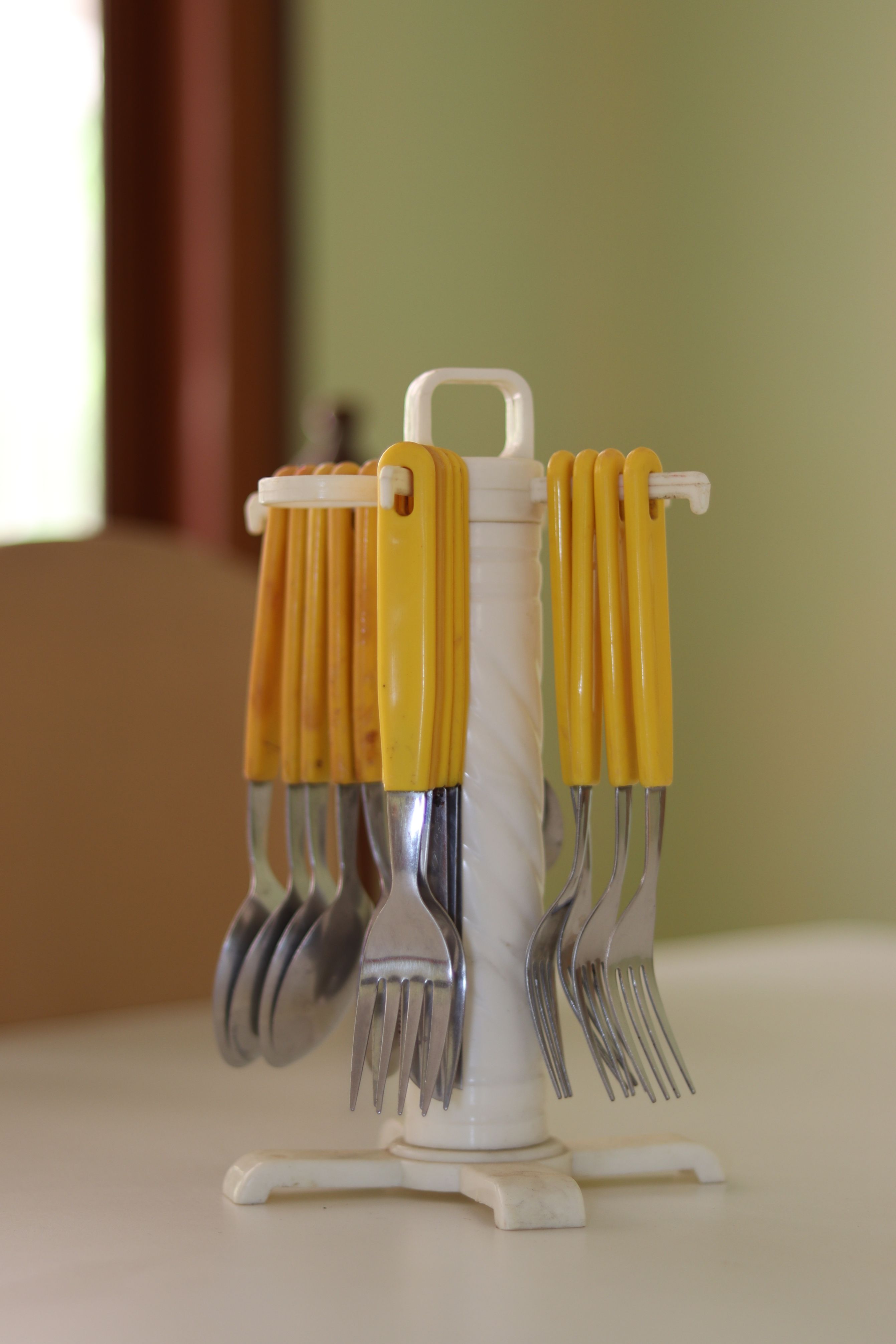 Yellow Handled Forks on a Rotating Holder · Free Stock Photo