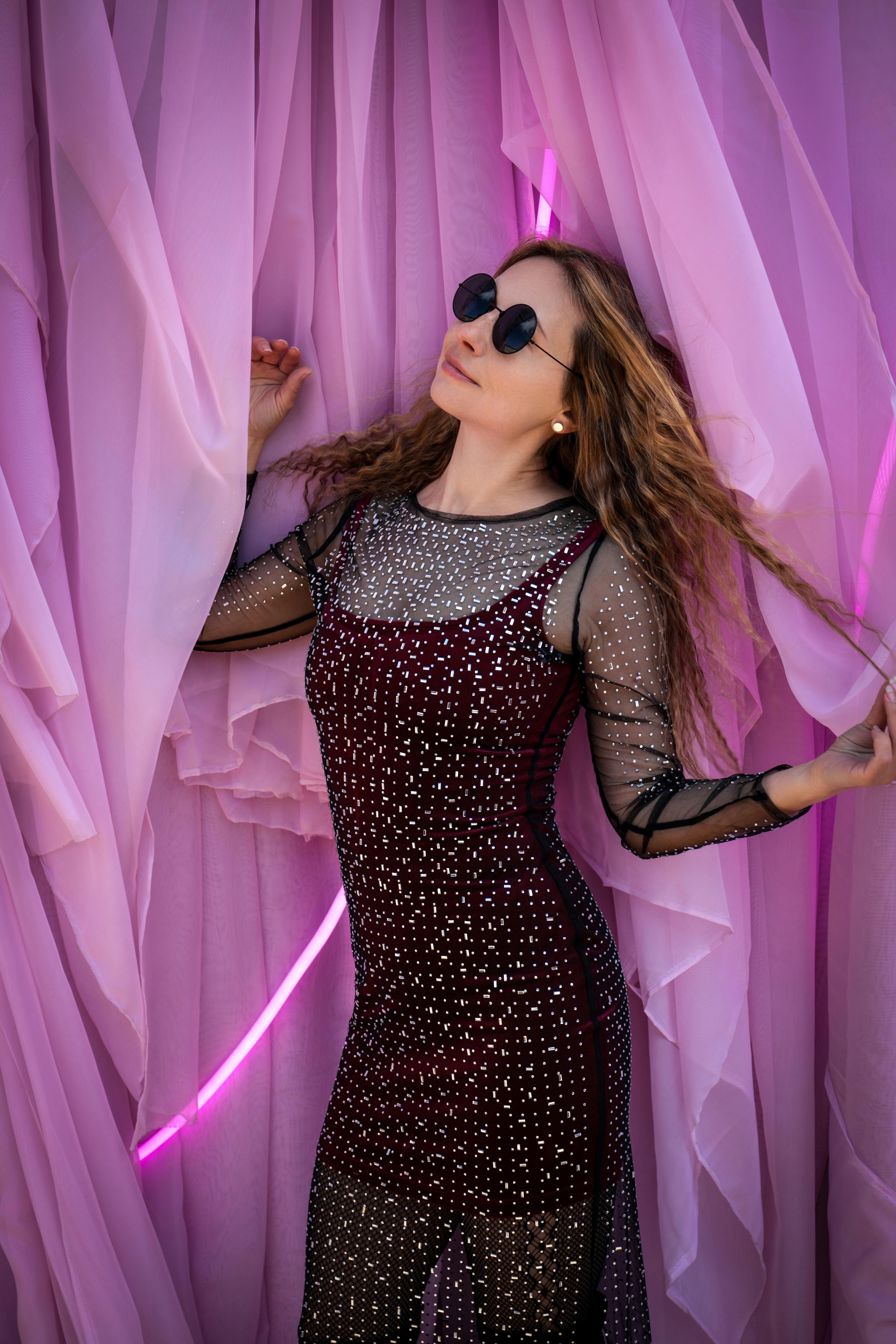 Stylish Woman Posing with Pink Curtain Backdrop · Free Stock Photo