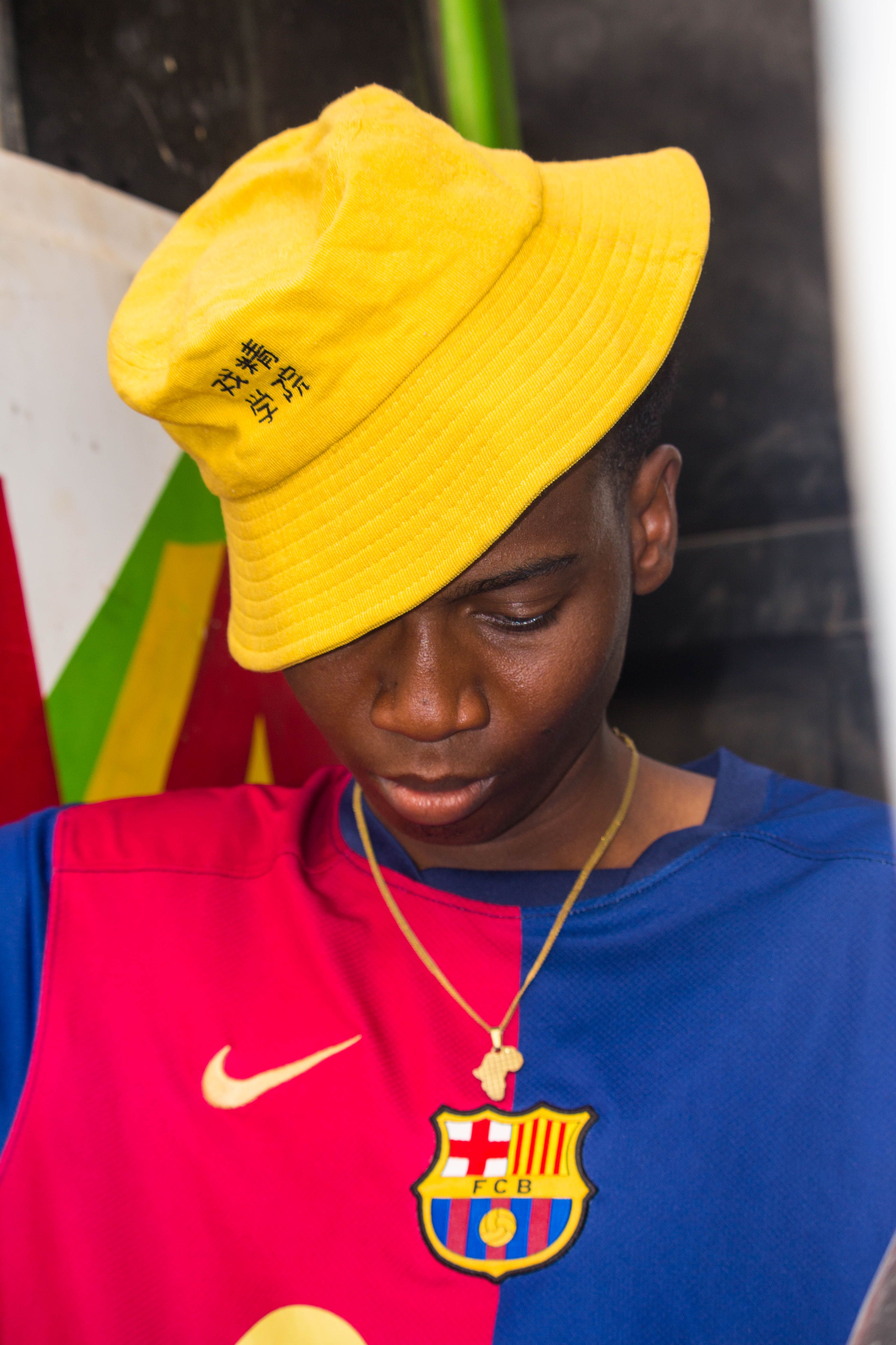 Young Man in Vibrant Sports Jersey and Yellow Hat · Free Stock Photo