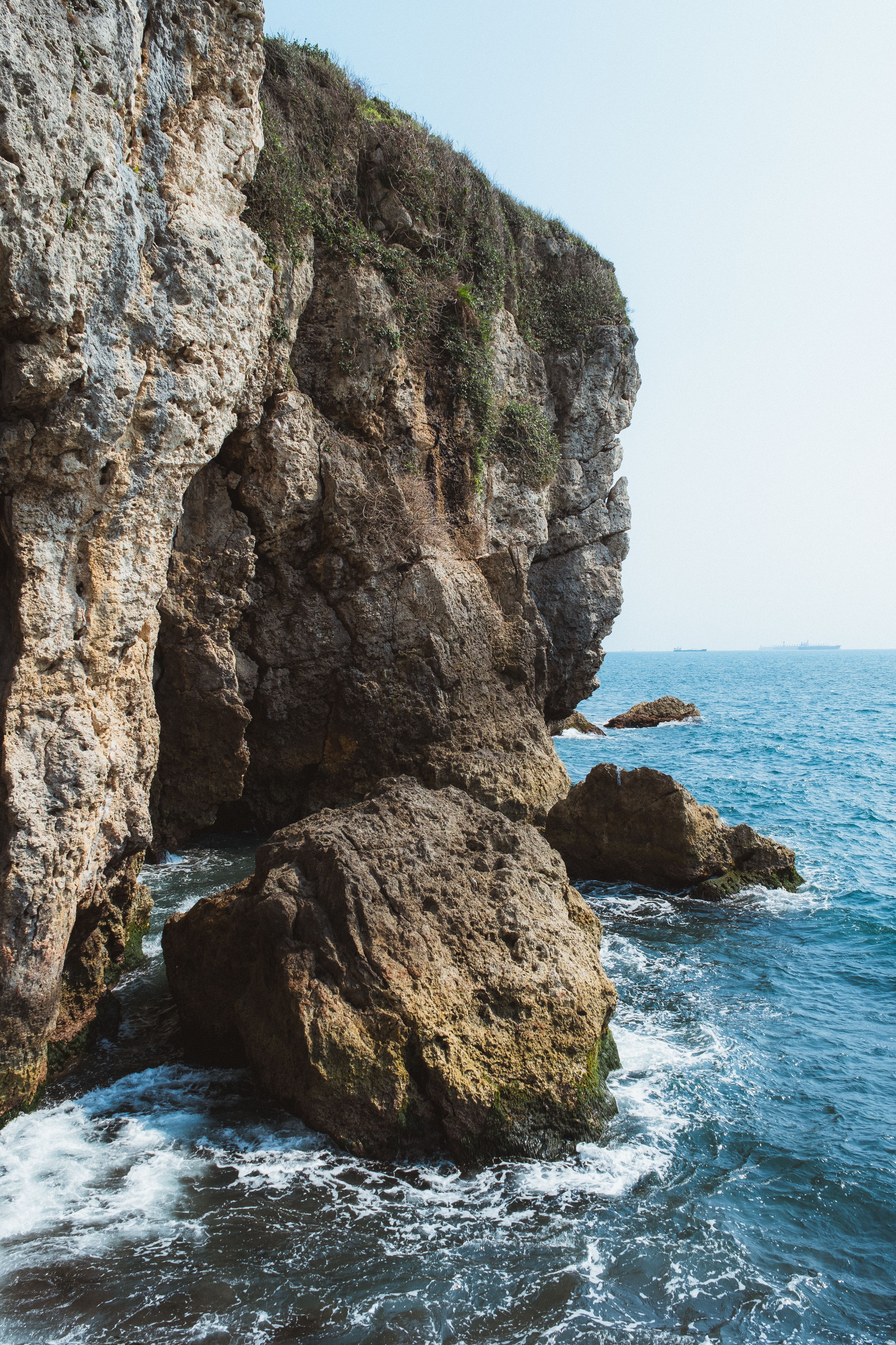 Dramatic Rocky Seaside Cliff with Ocean Waves · Free Stock Photo