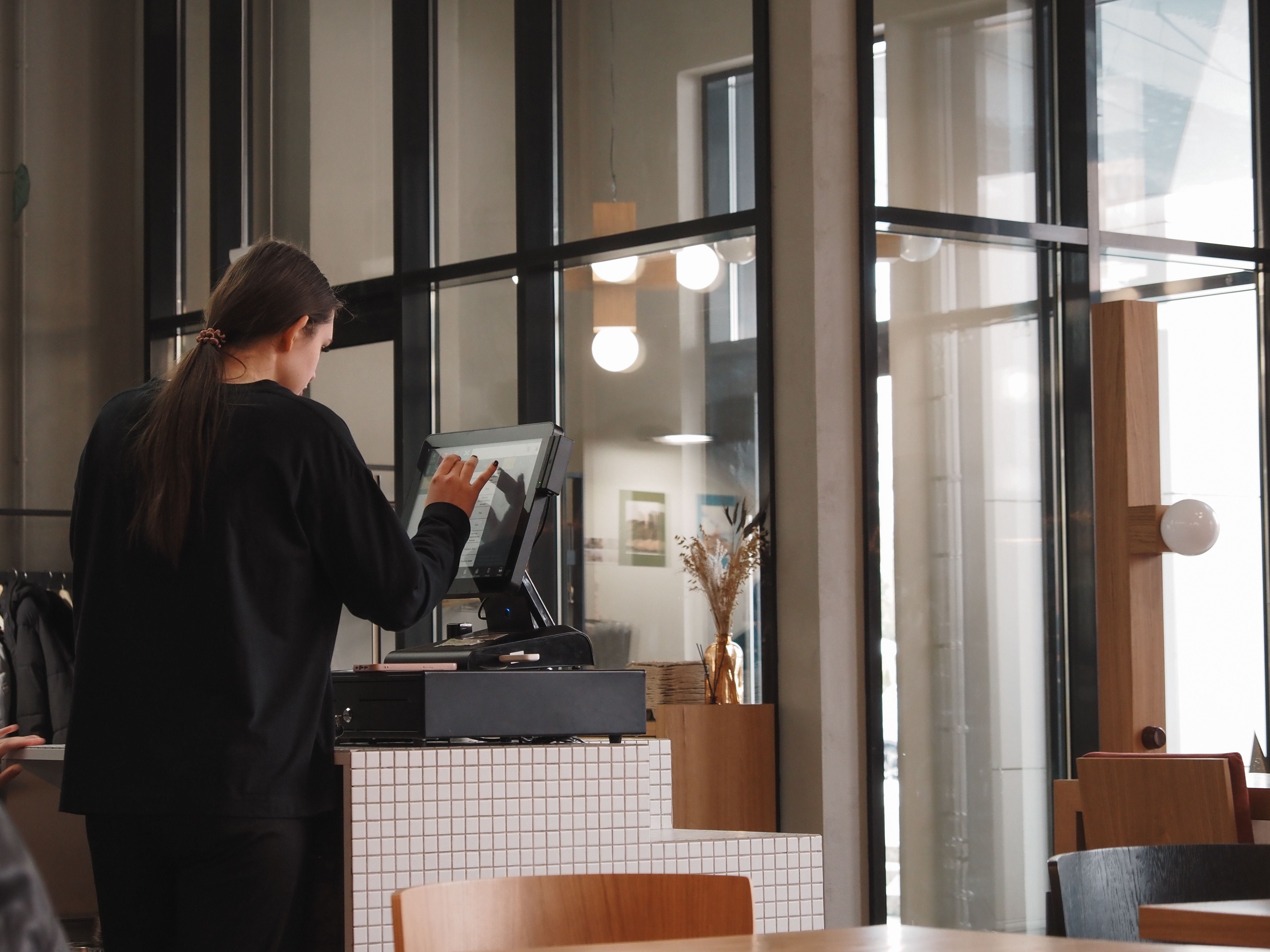 Restaurant Cashier Operating Touchscreen Register · Free Stock Photo