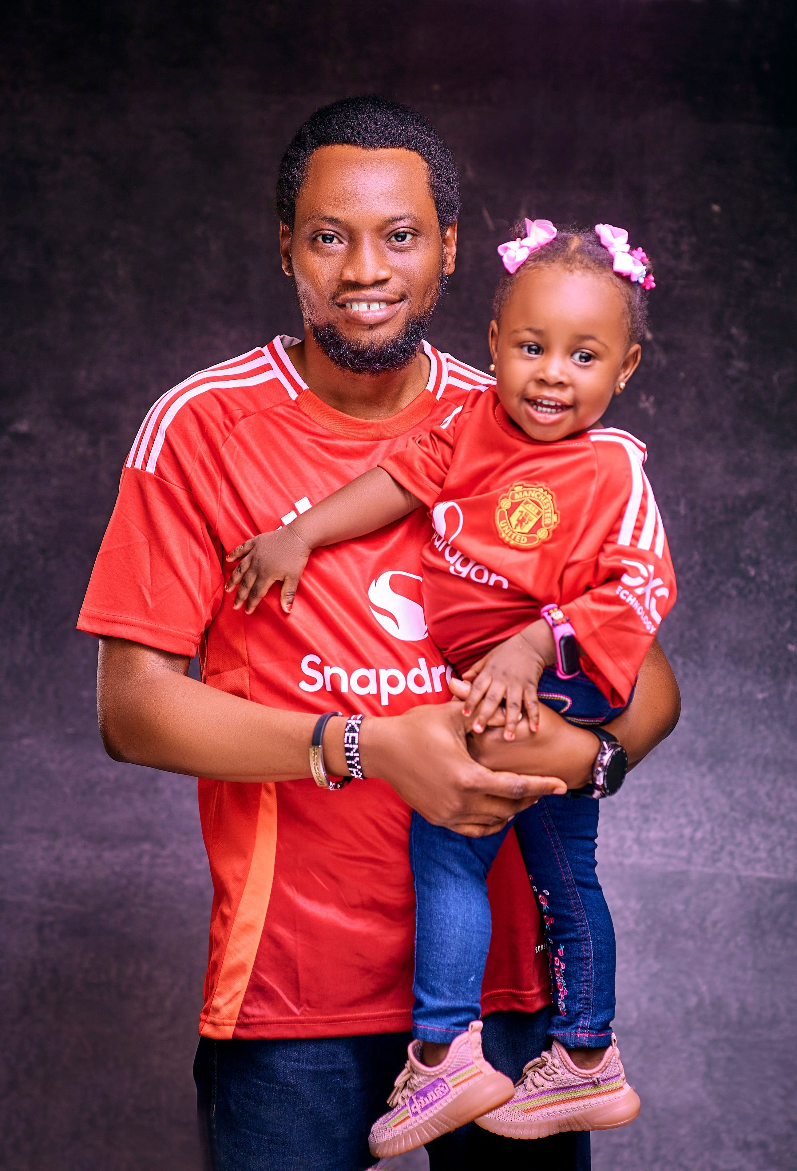 Father and Daughter in Matching Sports Jerseys · Free Stock Photo