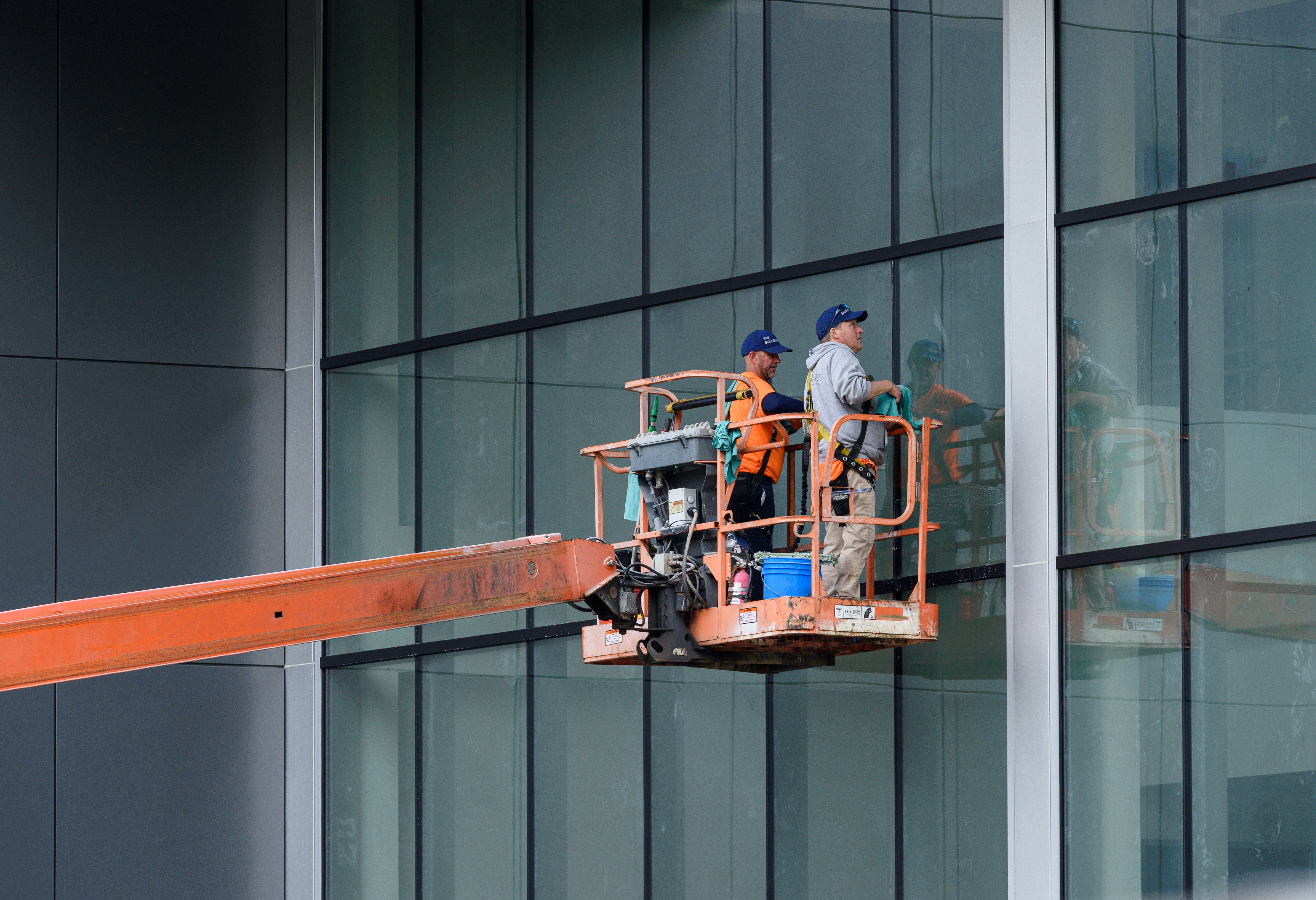 Workers on Cherry Picker Cleaning Windows · Free Stock Photo