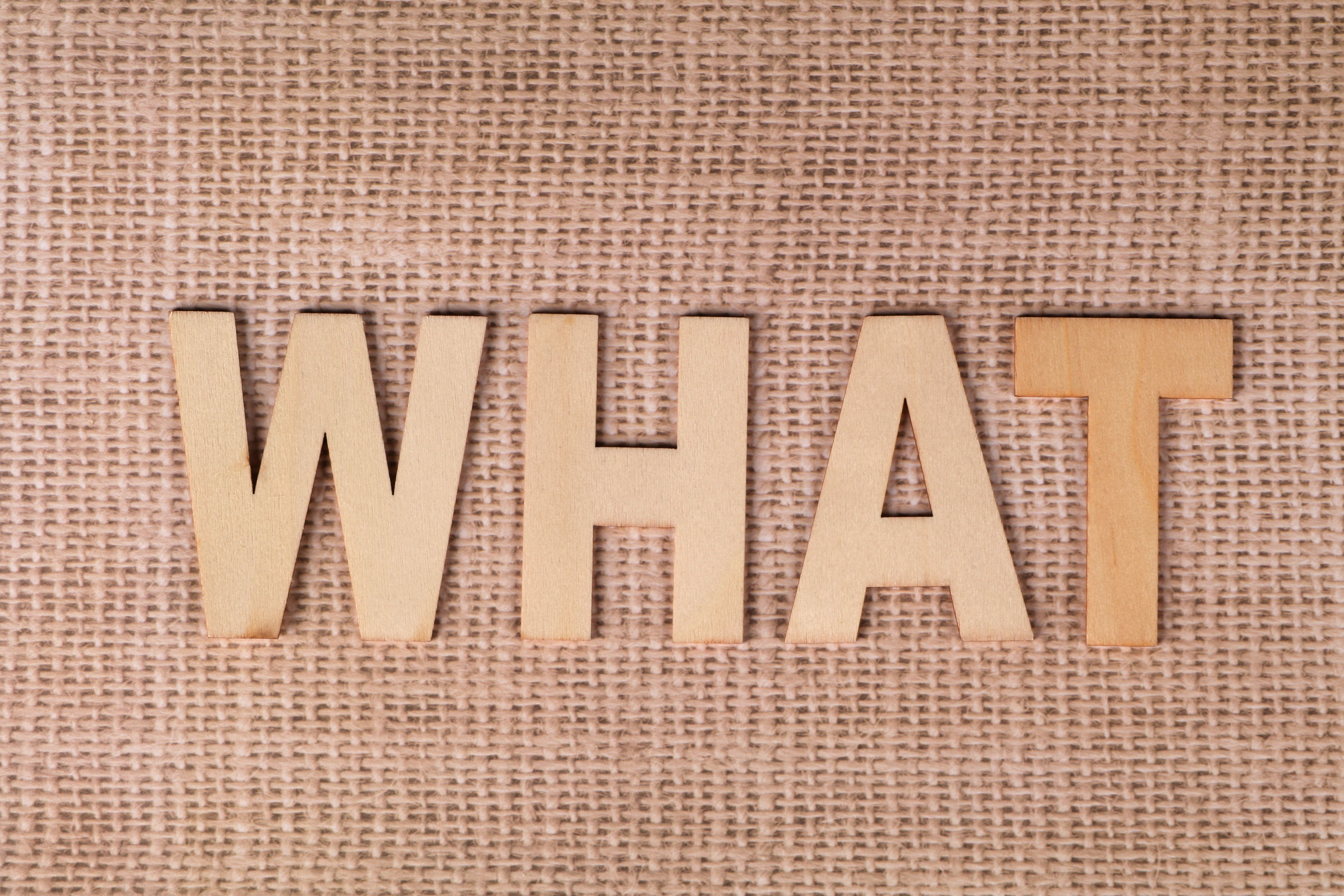 Wooden Letters Spelling WHAT on Burlap · Free Stock Photo