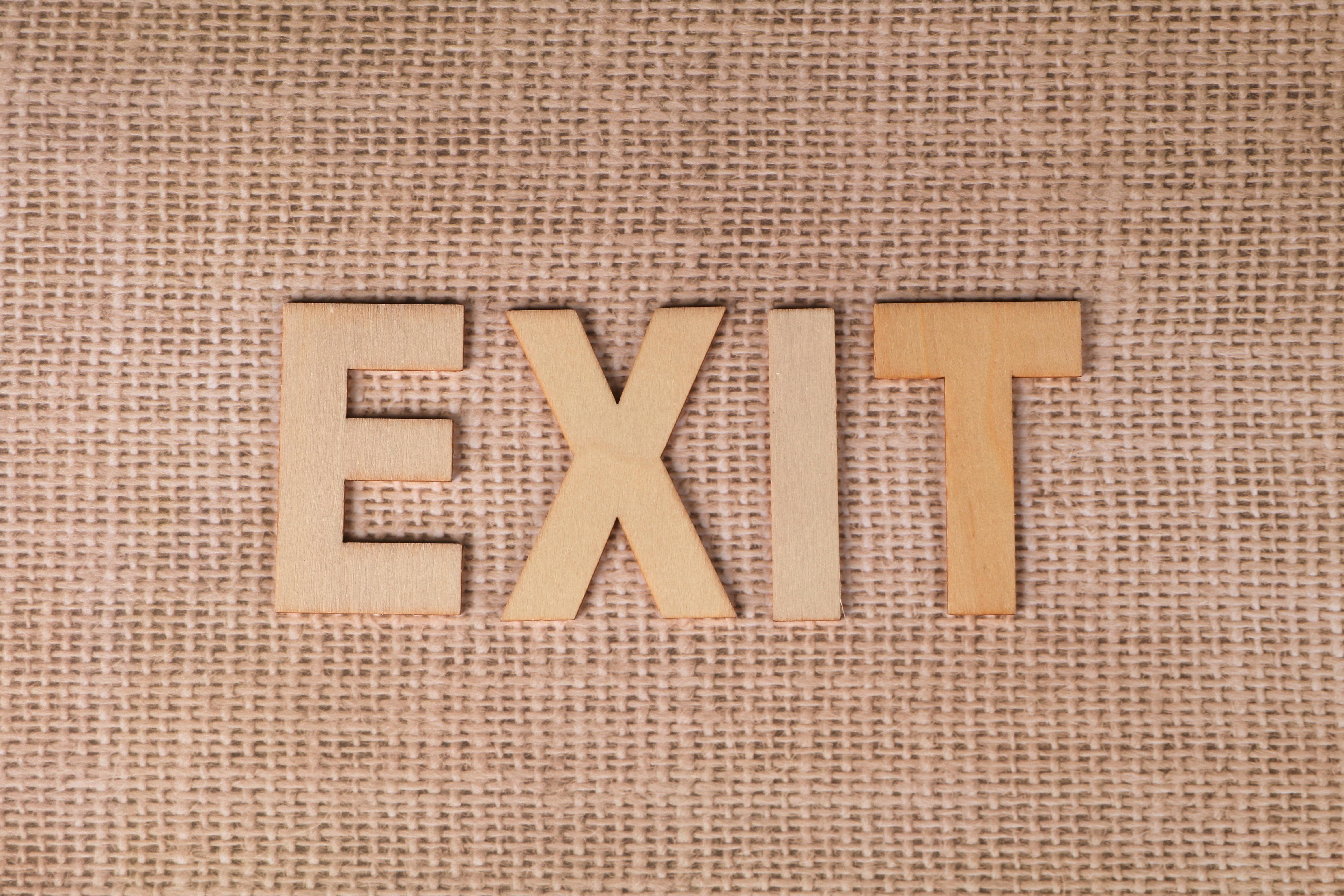 Wooden Exit Sign on Burlap Background · Free Stock Photo