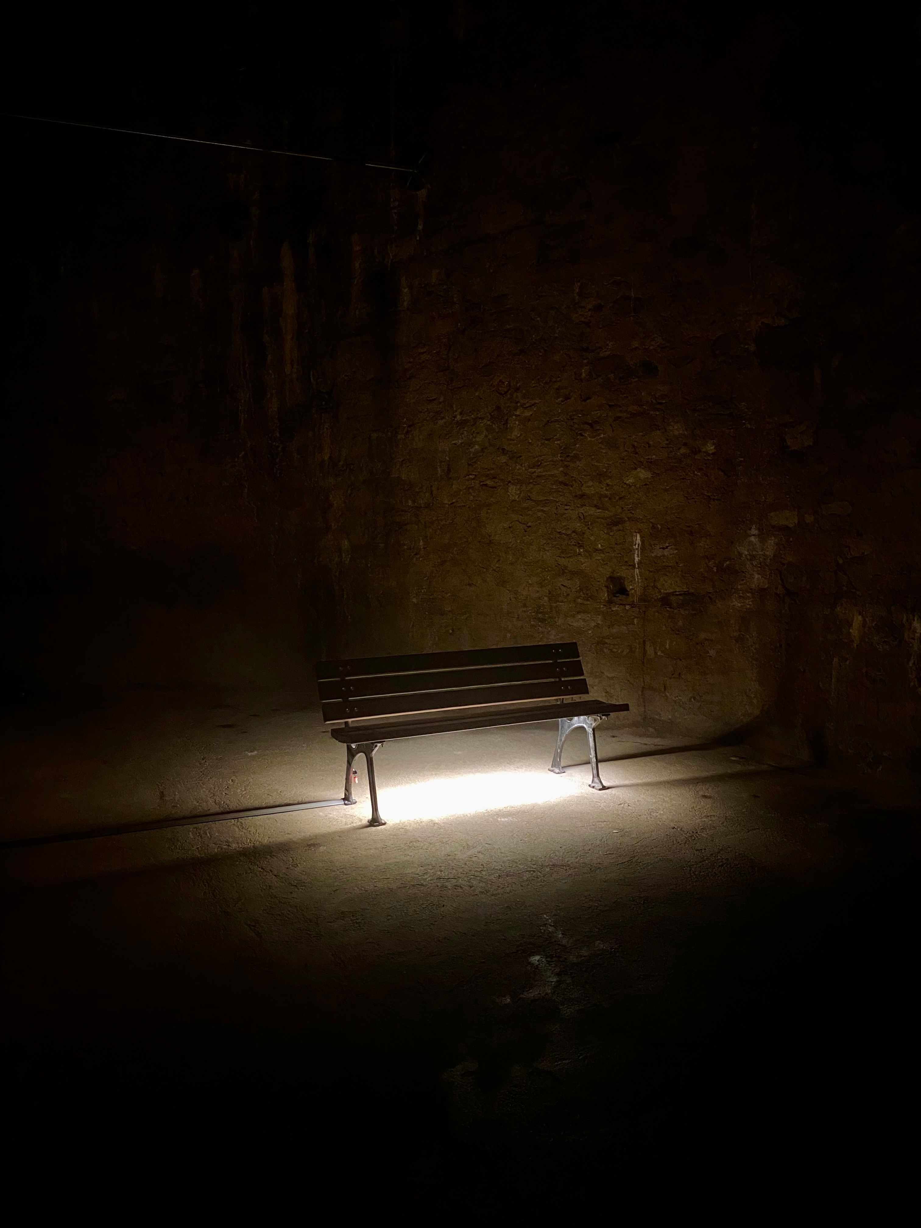 Lonely Bench in Dimly Lit Urban Setting · Free Stock Photo