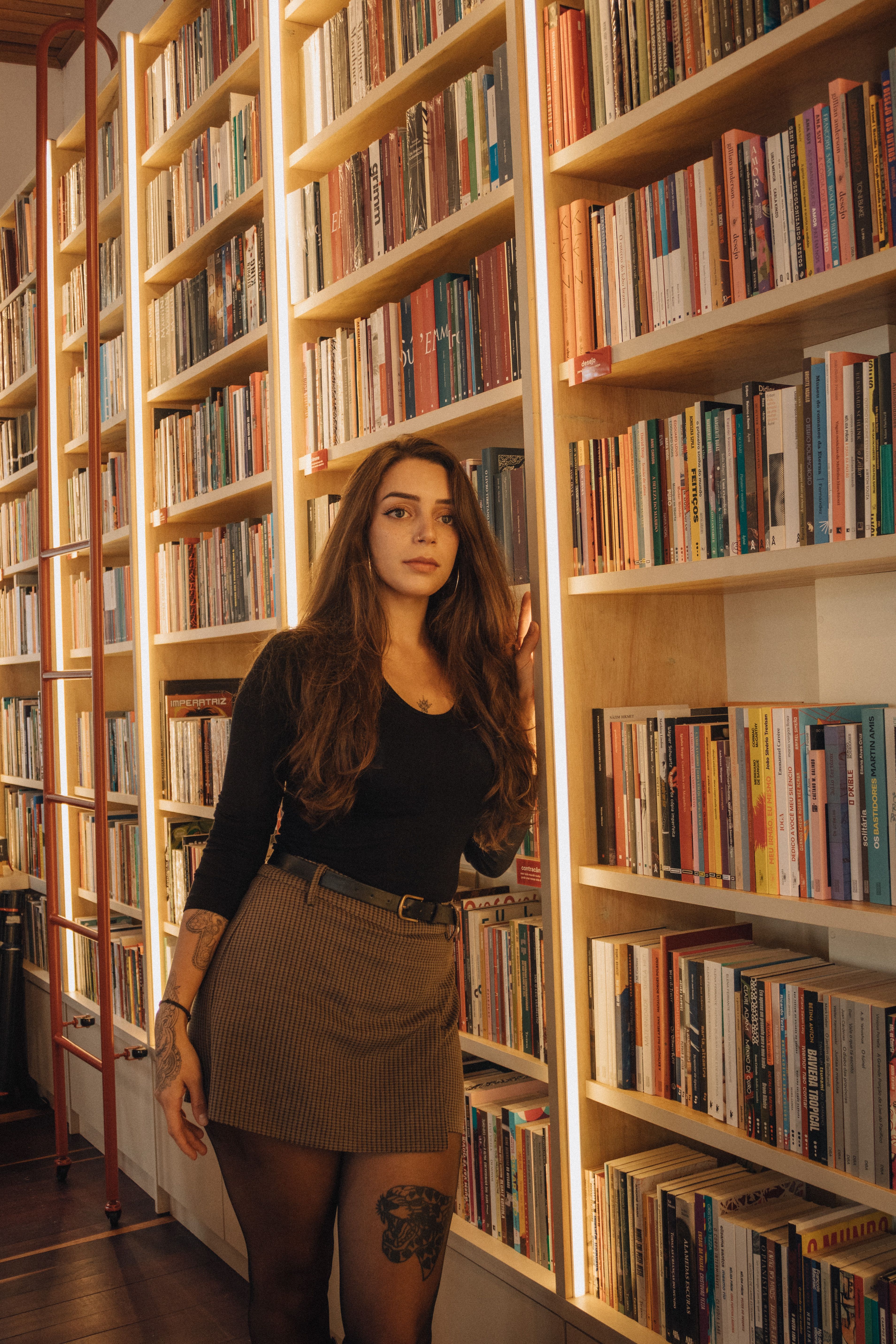 Woman in a Library Surrounded by Books · Free Stock Photo
