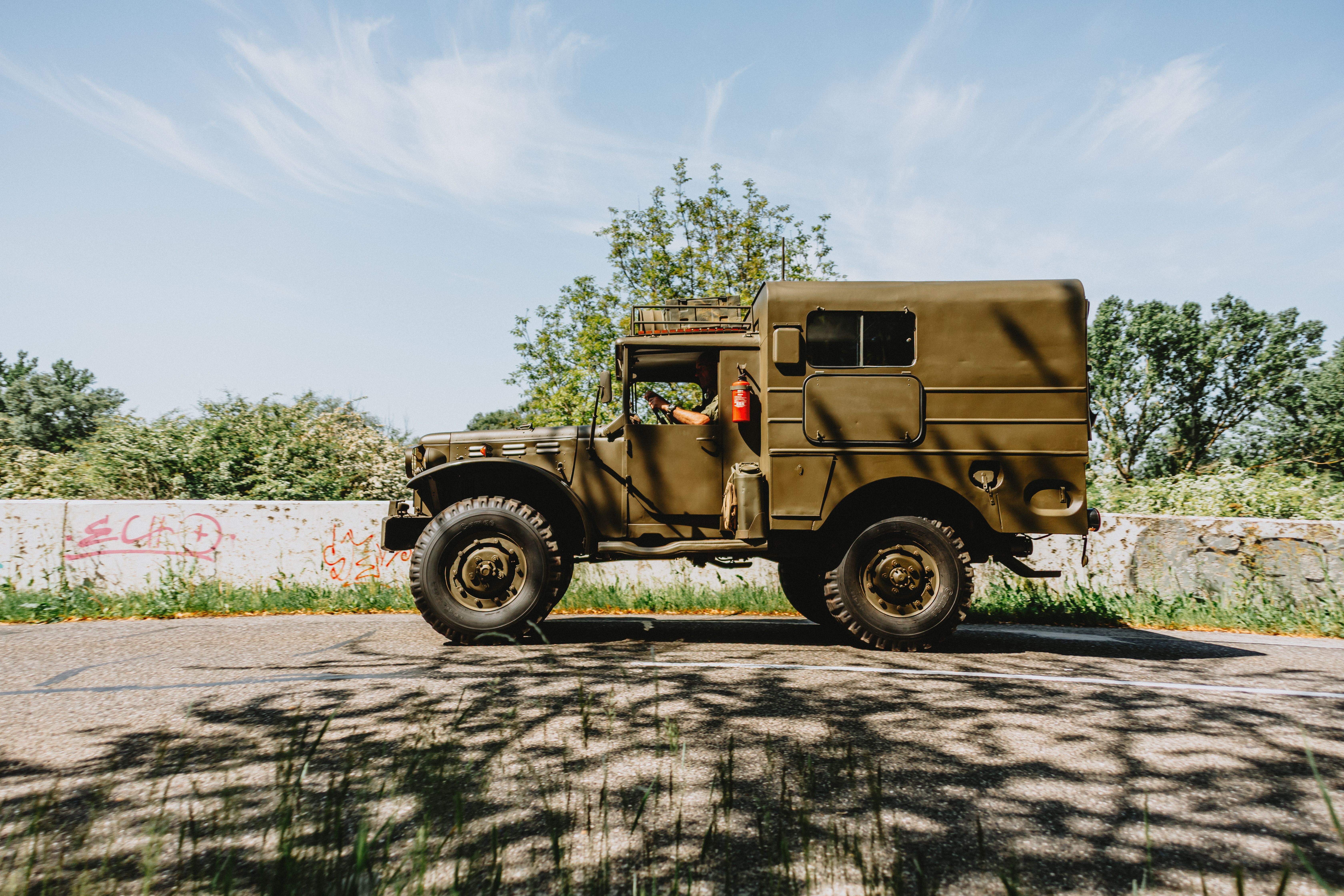Vintage Military Vehicle Driving Outdoors · Free Stock Photo