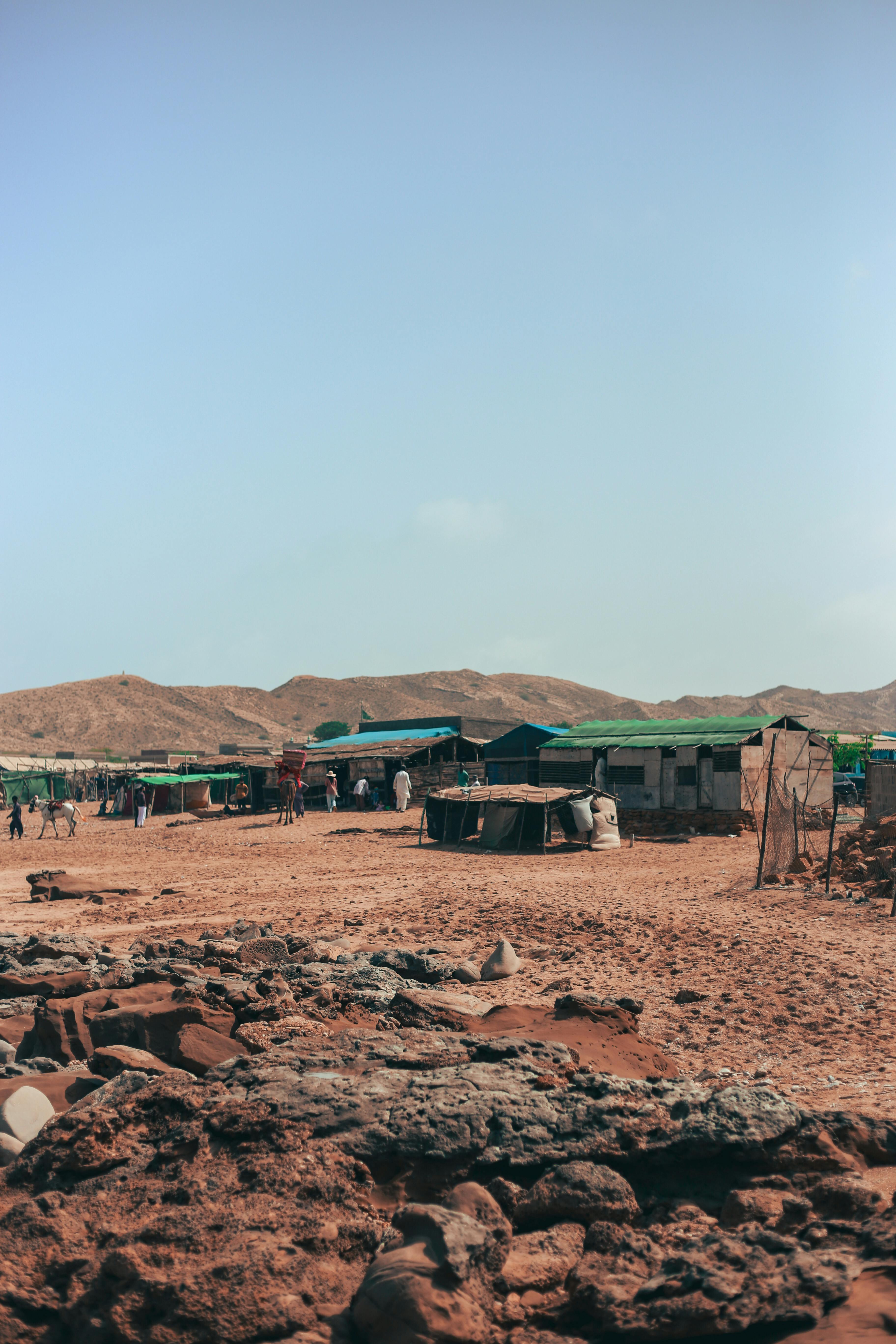 Rustic Desert Settlement with Distant Hills · Free Stock Photo