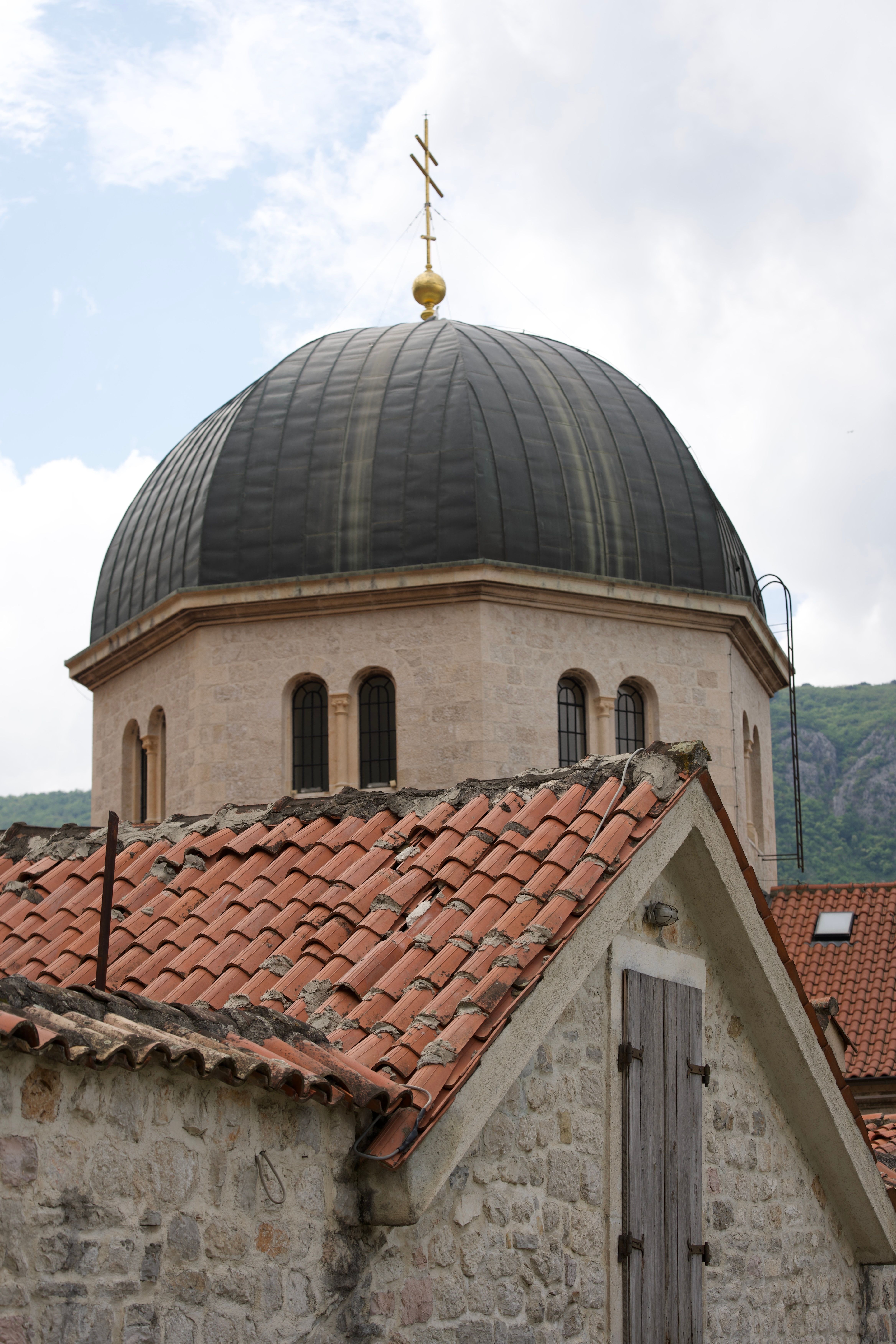 Historic Church Dome Overlooking Red Tiled Roofs · Free Stock Photo
