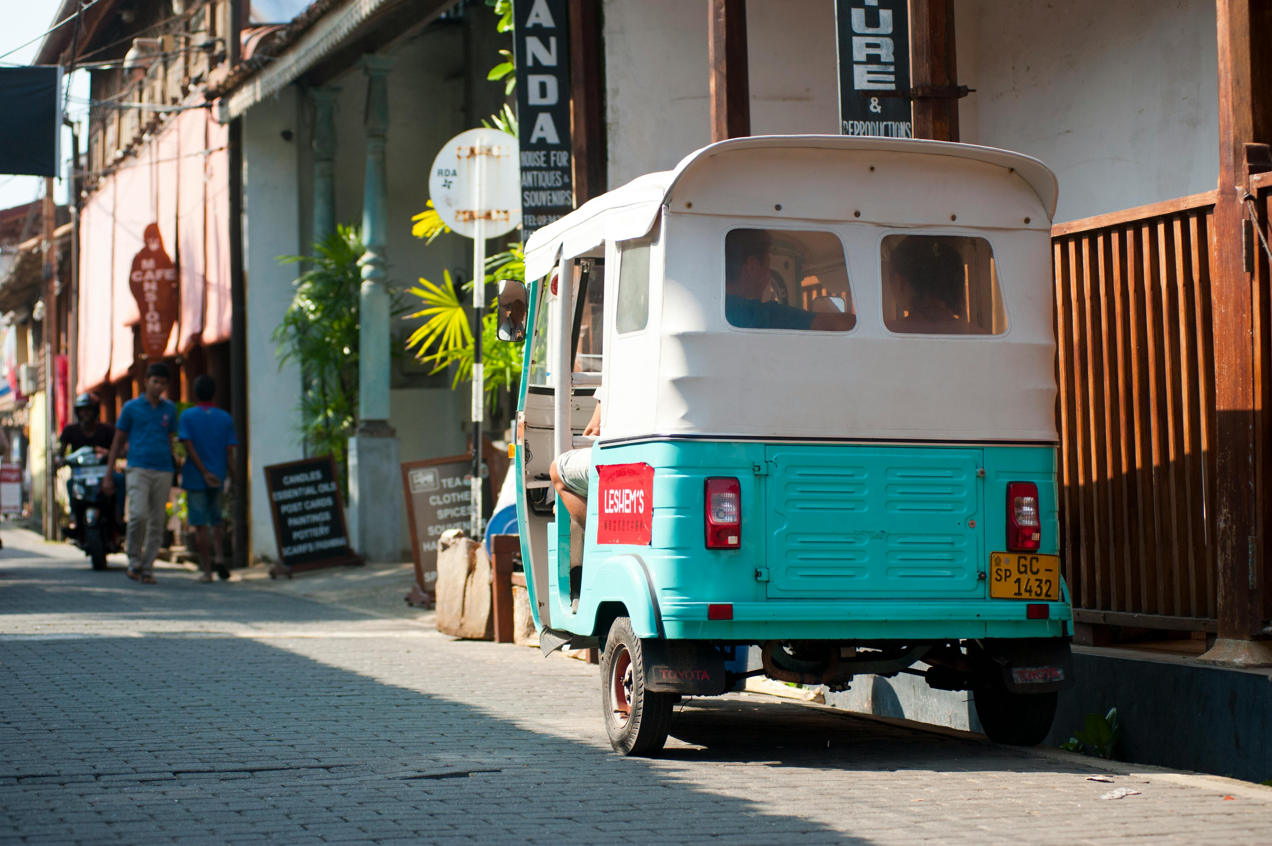 White and Teal Auto Rickshaw Beside Brown Wooden Rails · Free Stock Photo